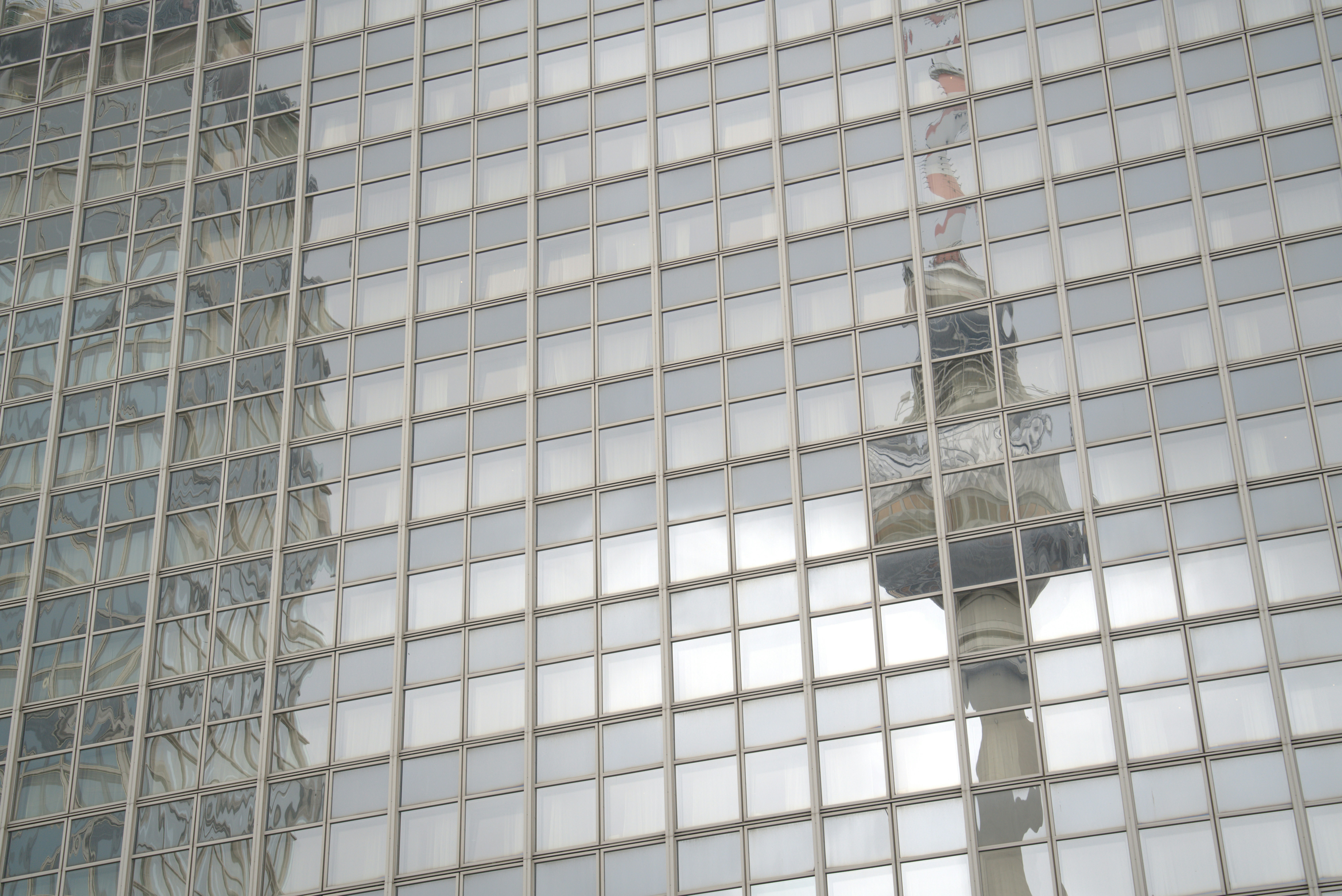 Glass Facade Echo: Reflections of a Tower in a Grid of Windows