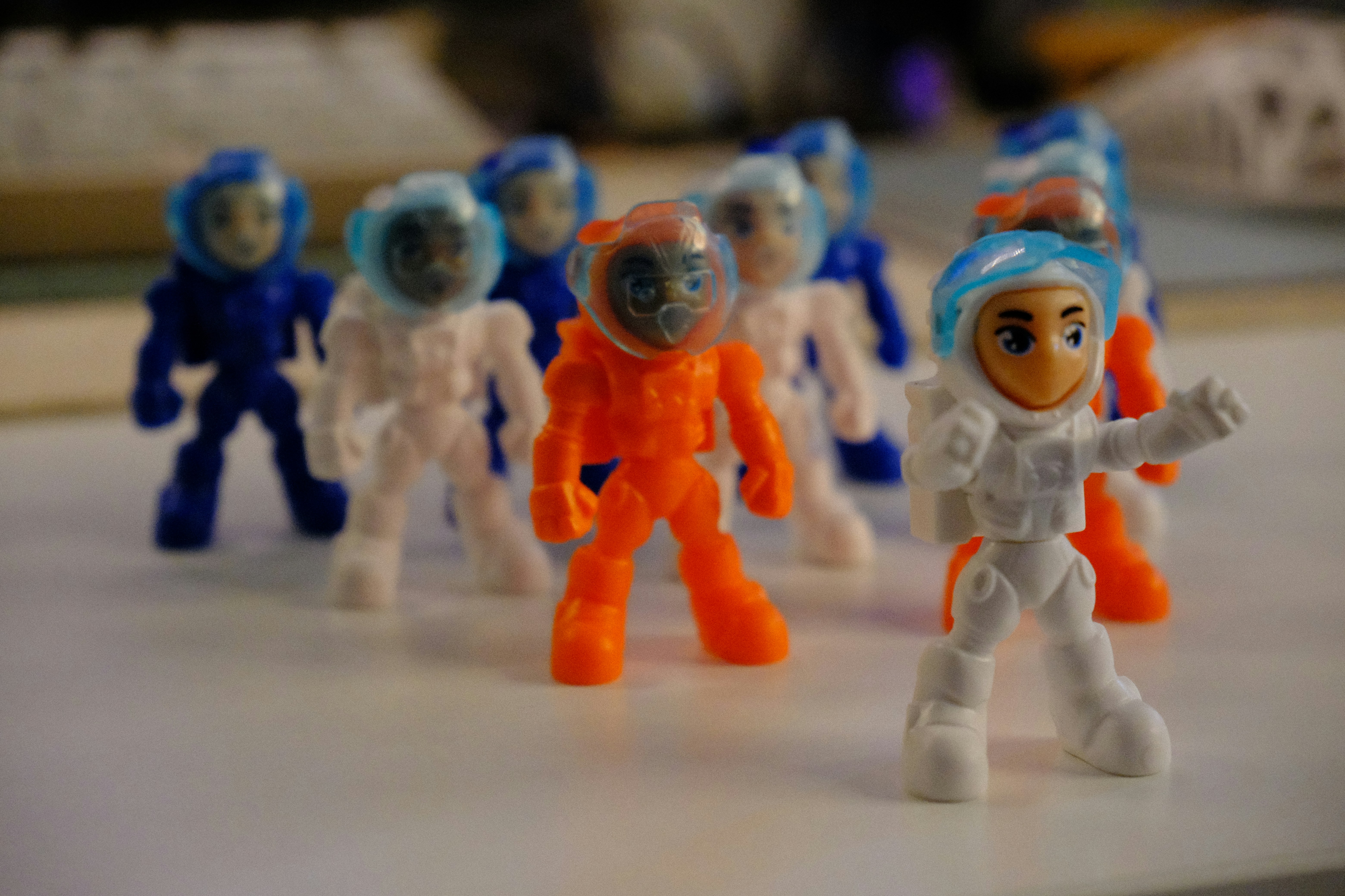 Many colorful astronaut figures standing together.