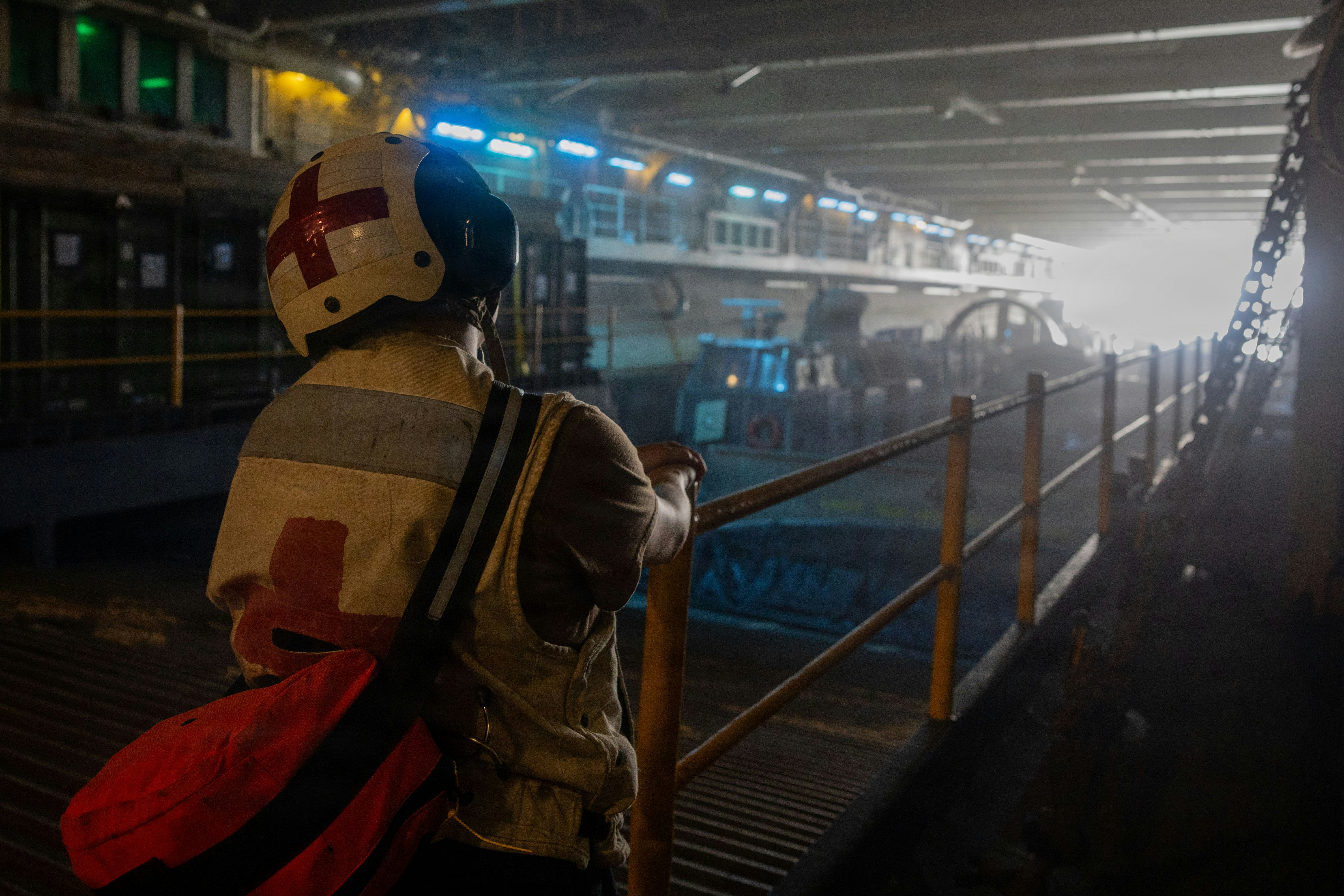 U.S. Navy Hospital Corpsman 2nd Class Kristen Johnson, assigned to Wasp-class amphibious assault ship USS Boxer (LHD 4), conducts a safety watch during well deck operations, June 5, 2026. Boxer, flagship of the Boxer Amphibious Ready Group, is underway with the 11th Marine Expeditionary Unit in the U.S. 7th Fleet area of operations. U.S. 7th Fleet, the Navy’s largest forward-deployed numbered fleet, routinely interacts and operates with allies and partners to preserve a free and open Indo-Pacific. (U.S. Navy photo by Mass Communication Specialist Seaman Trace Gorsuch)