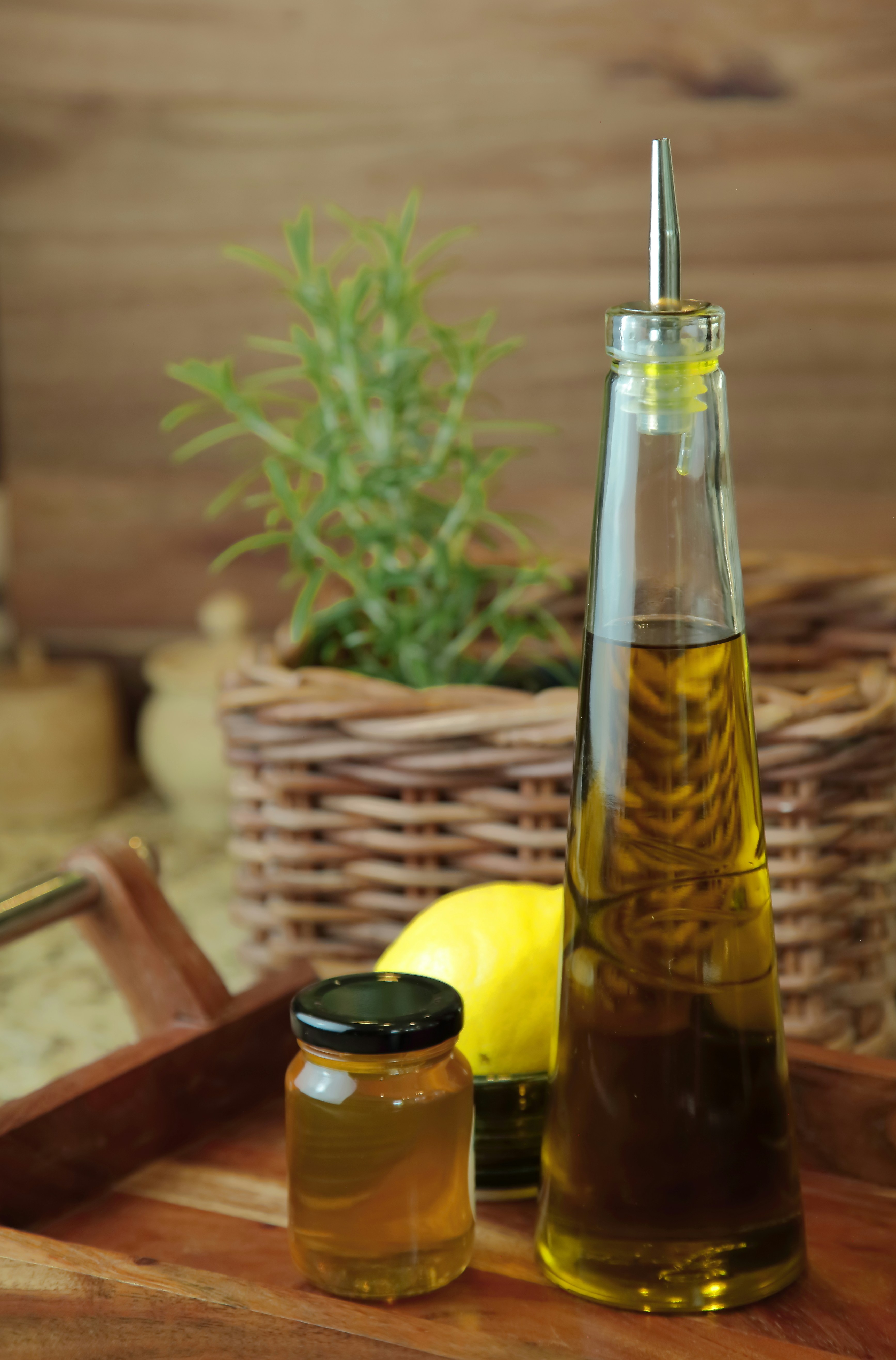 Olive Oil Still Life: A Glass Bottle with Honey Pot Amid Rosemary and Lemon