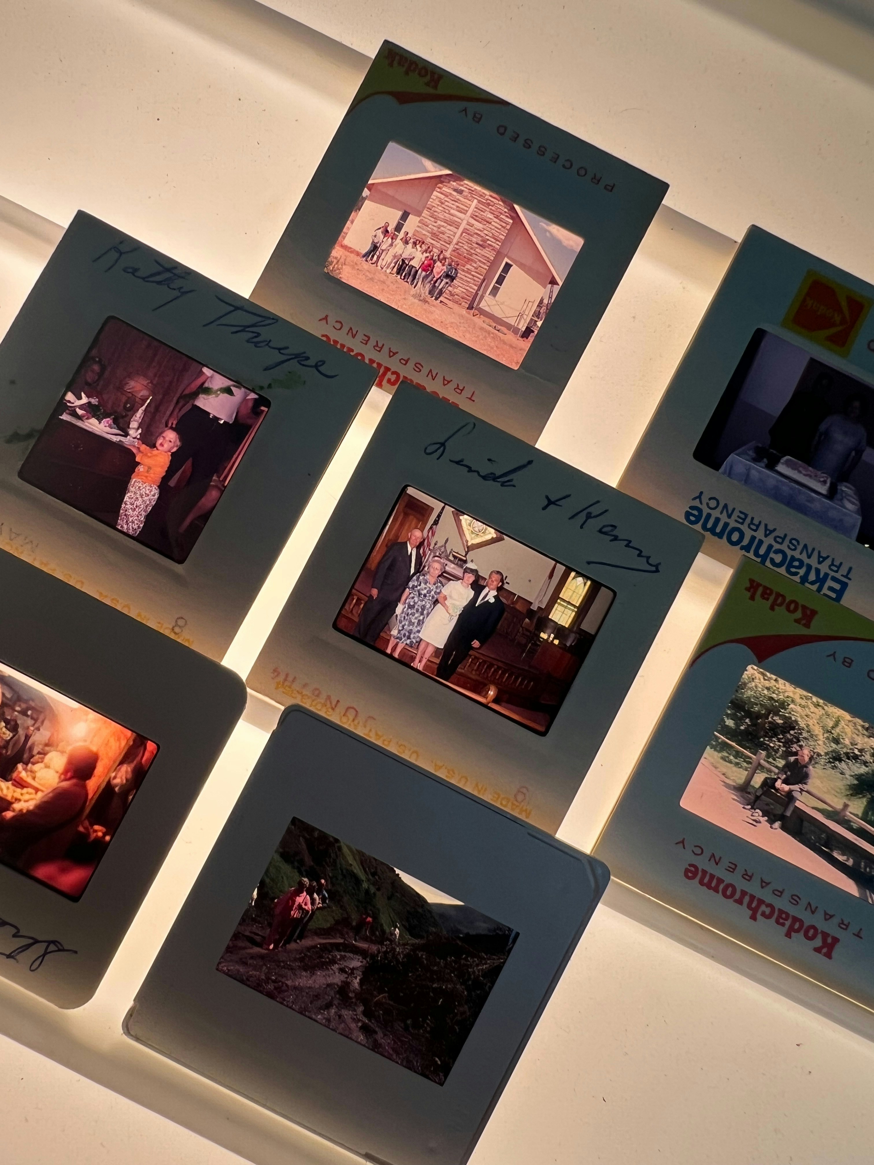 Vintage photographic slides with various images on a light.