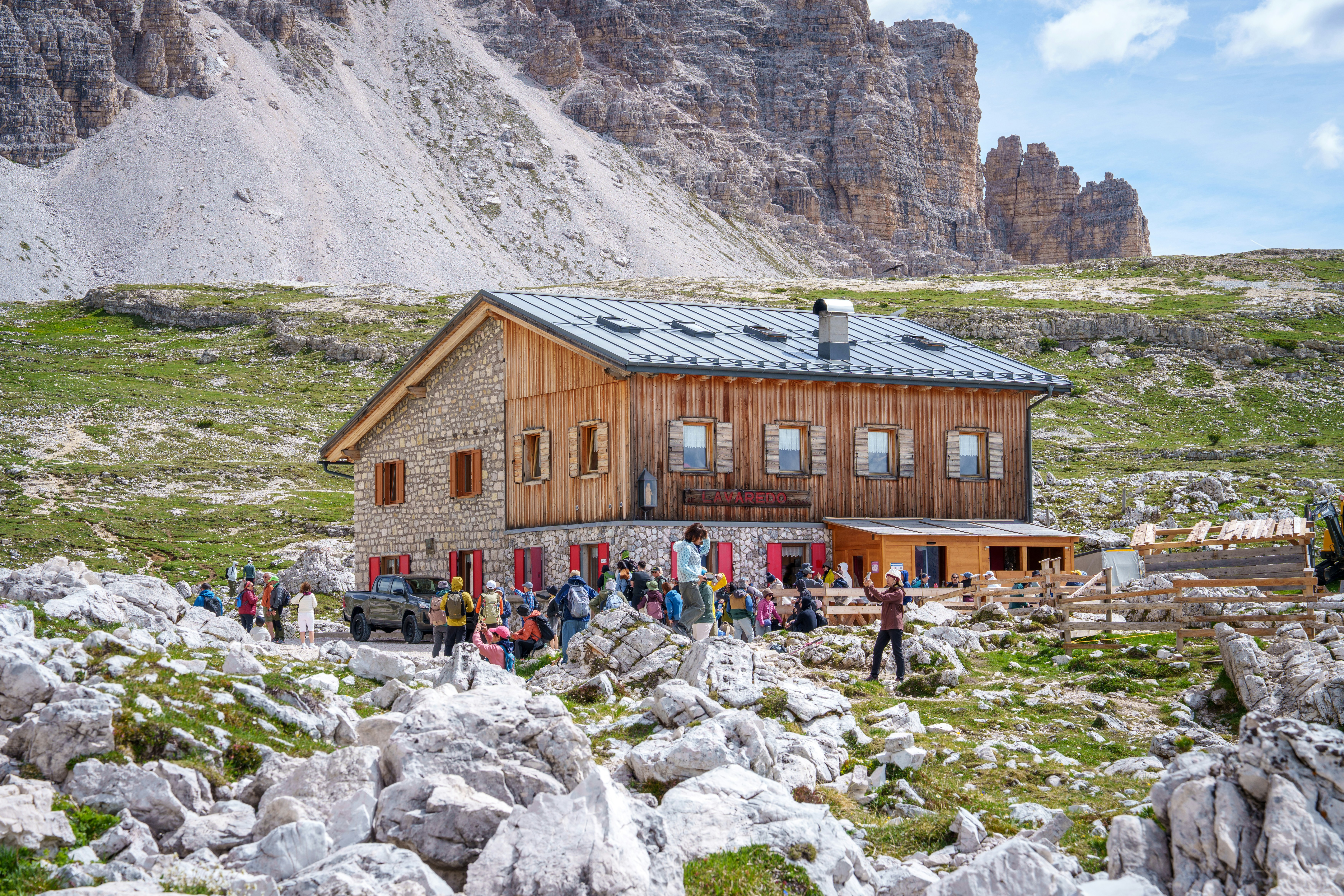 Mountain Hut Hub: People Gather at a Rustic Alpine Lodge