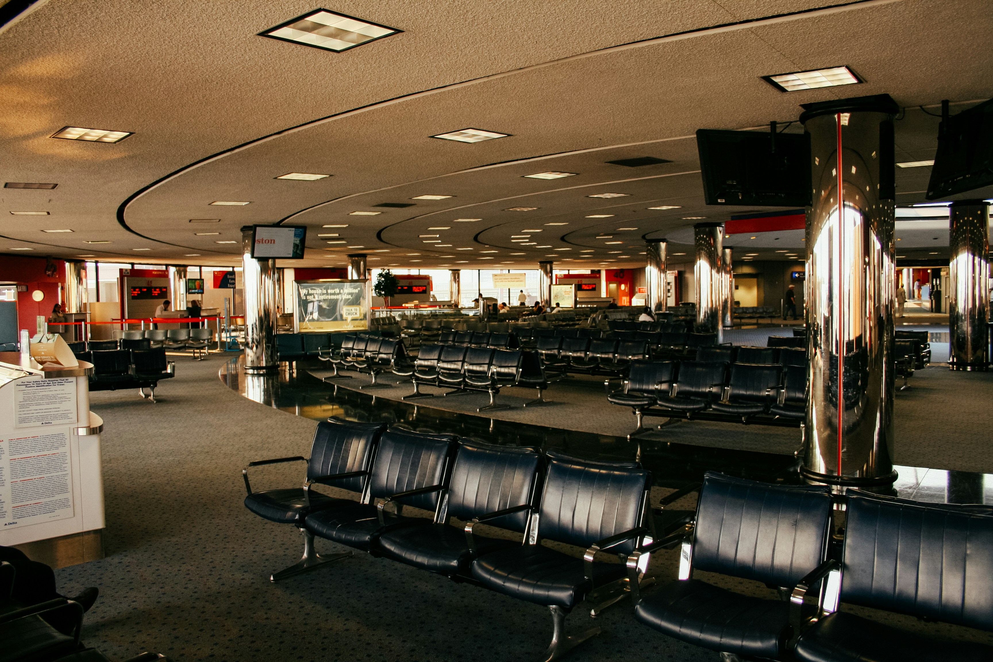 Vacant Terminal Echo: Rows of Seats Beneath Floating Monitors