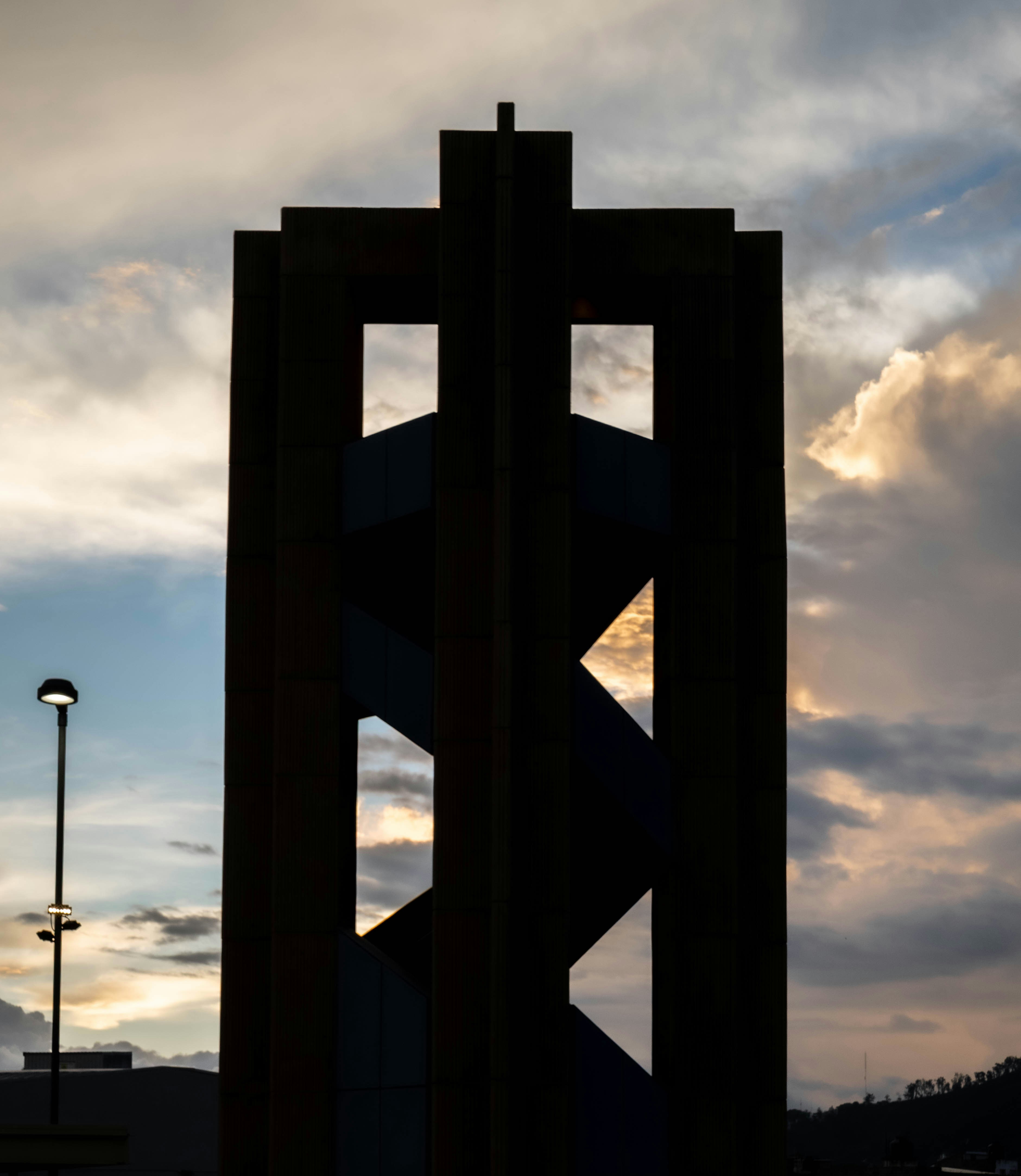 Silhouette Tower Against a Clouded Sunset