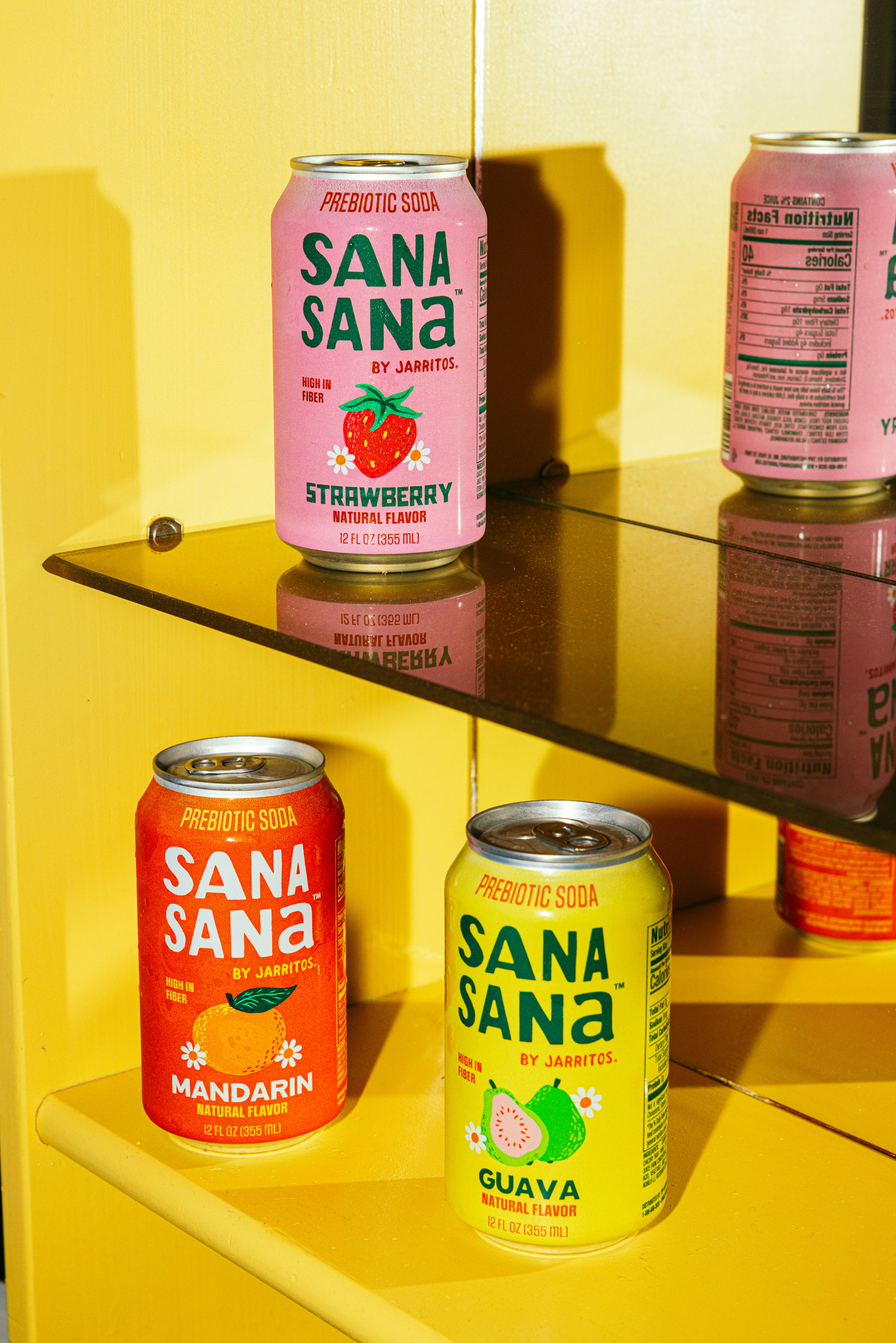 Sana Sana Soda Trio: Bright Cans on Sunny Yellow Shelves