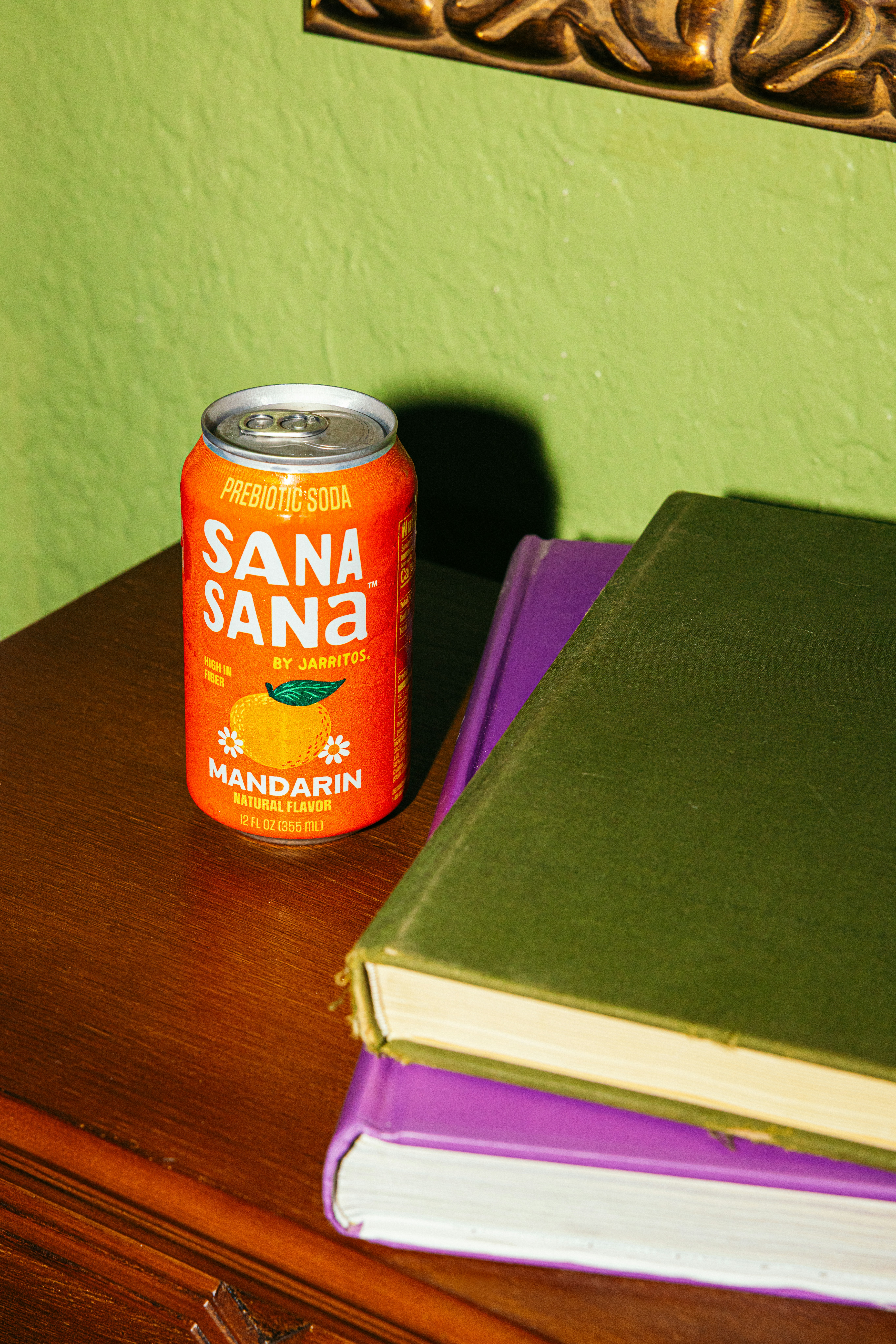 Mandarin Chill: A Soda Can Nestled Among Note Cards and Books