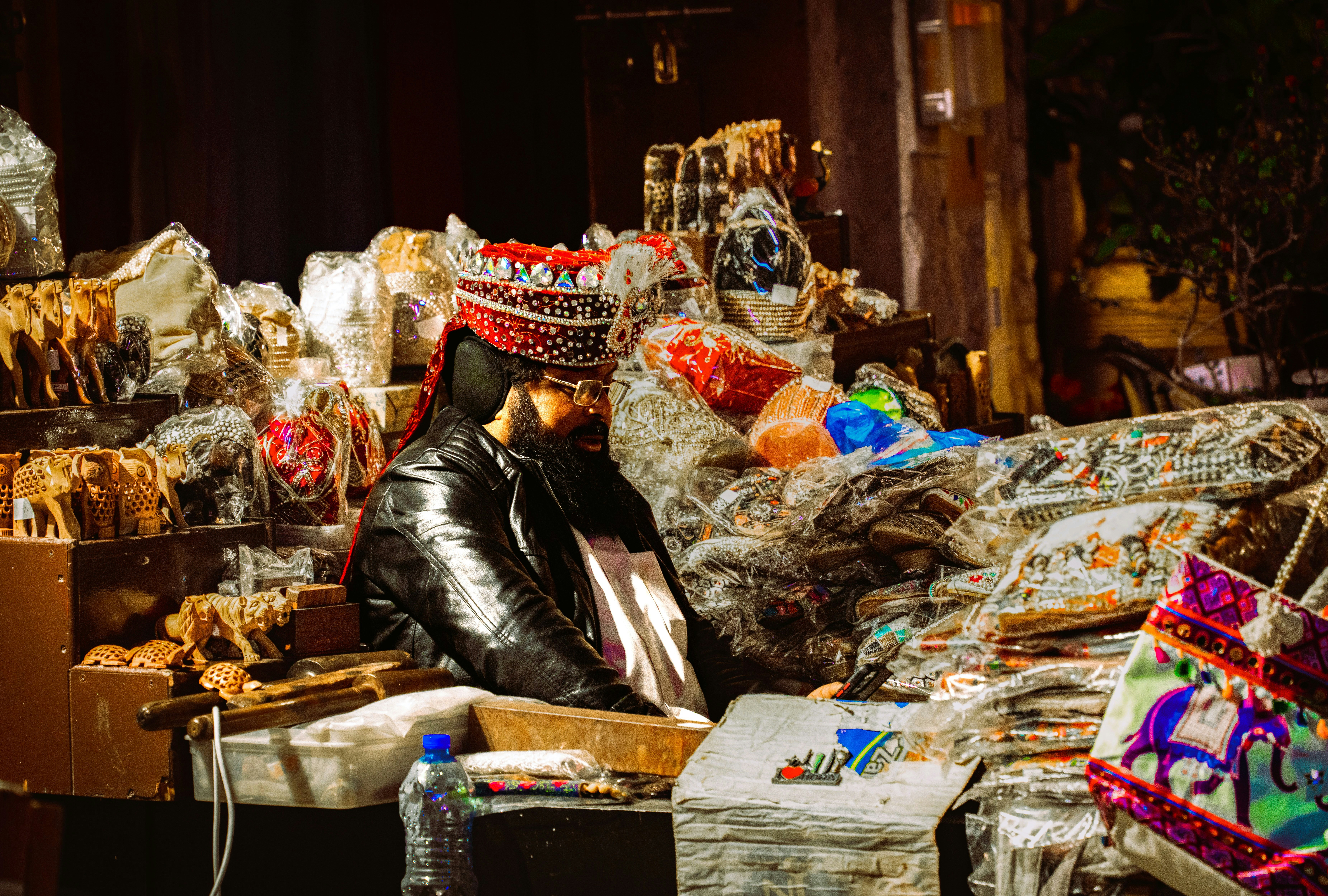 Night Market Comfort: A Hat-Sporting Vendor Nestled Among Plush Cushions