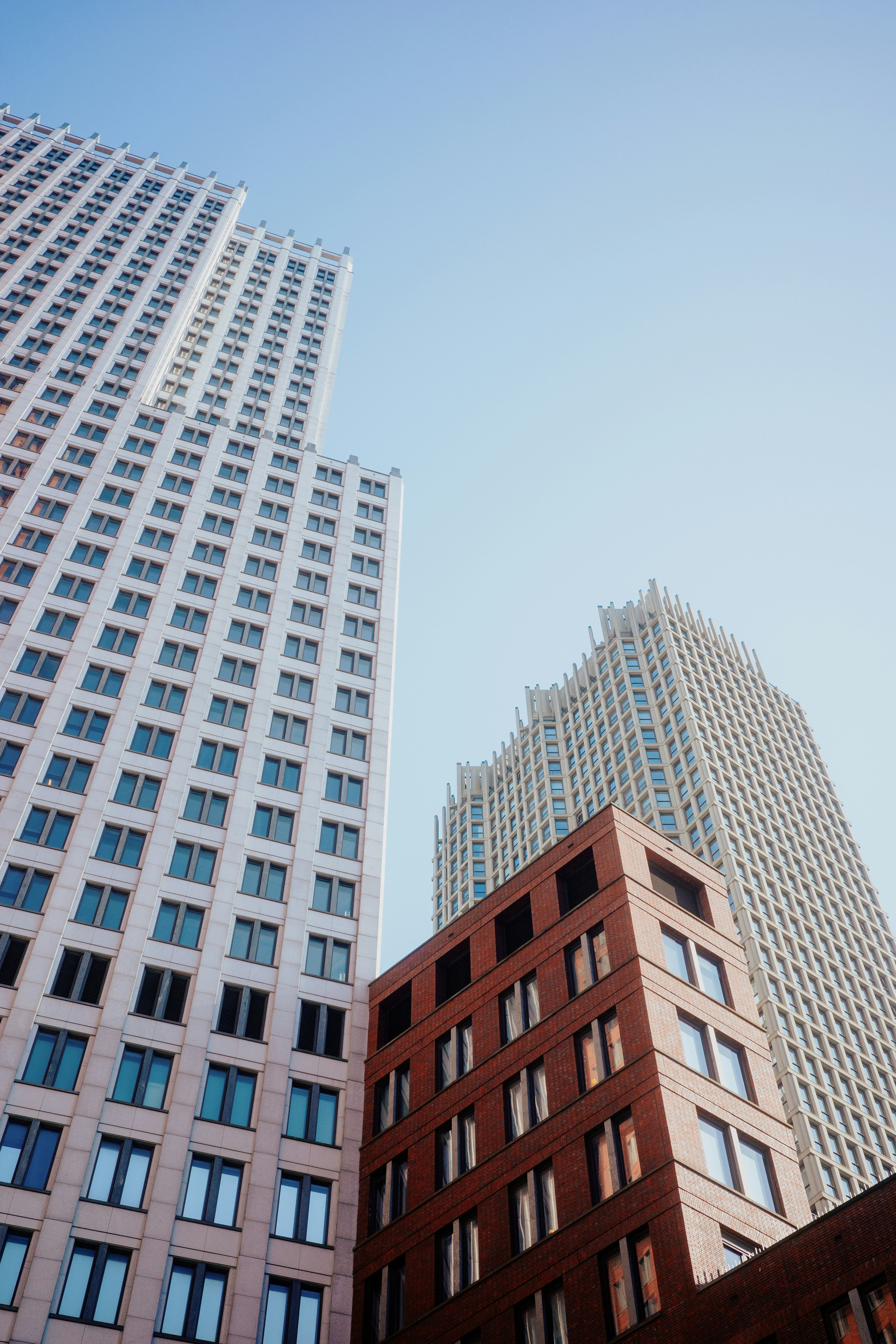 Skyward Facades: Concrete Cathedral Silhouettes Against a Clear Blue