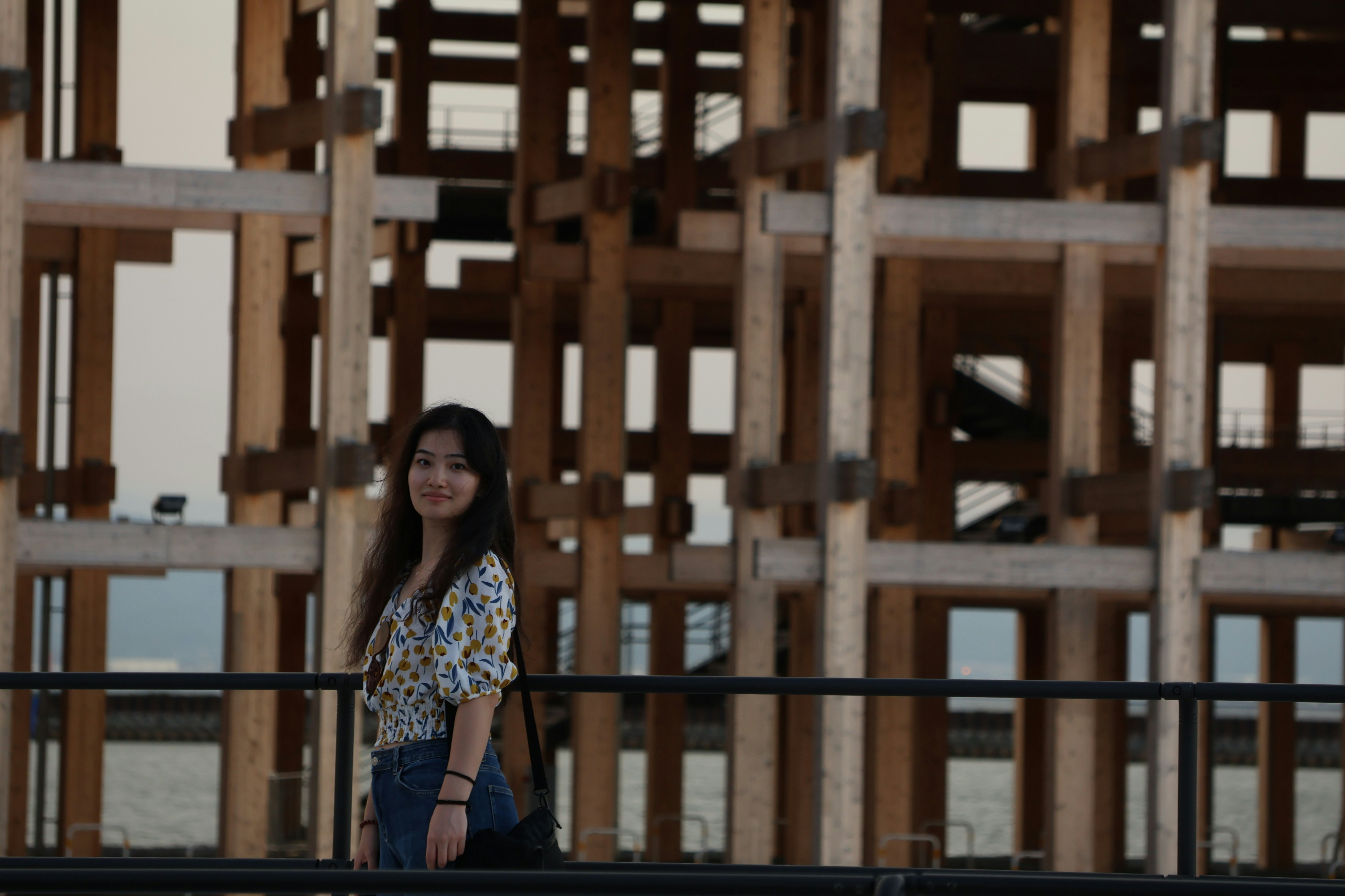 Girl on a Wooden Framework: Quiet Urban-Industrial Portrait