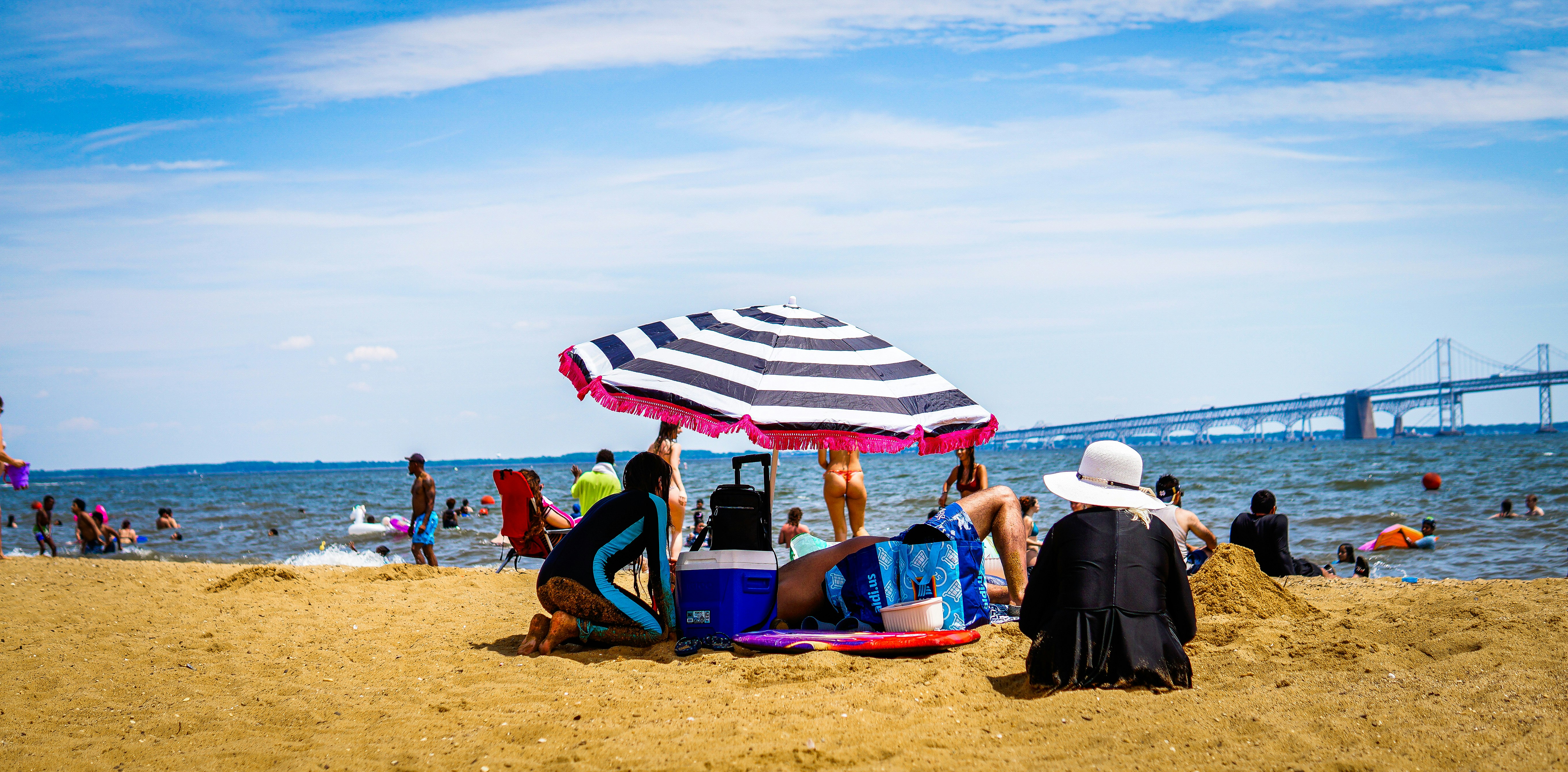 Striped Umbrella, Quiet Corner: A Beach Portrait of Leisure