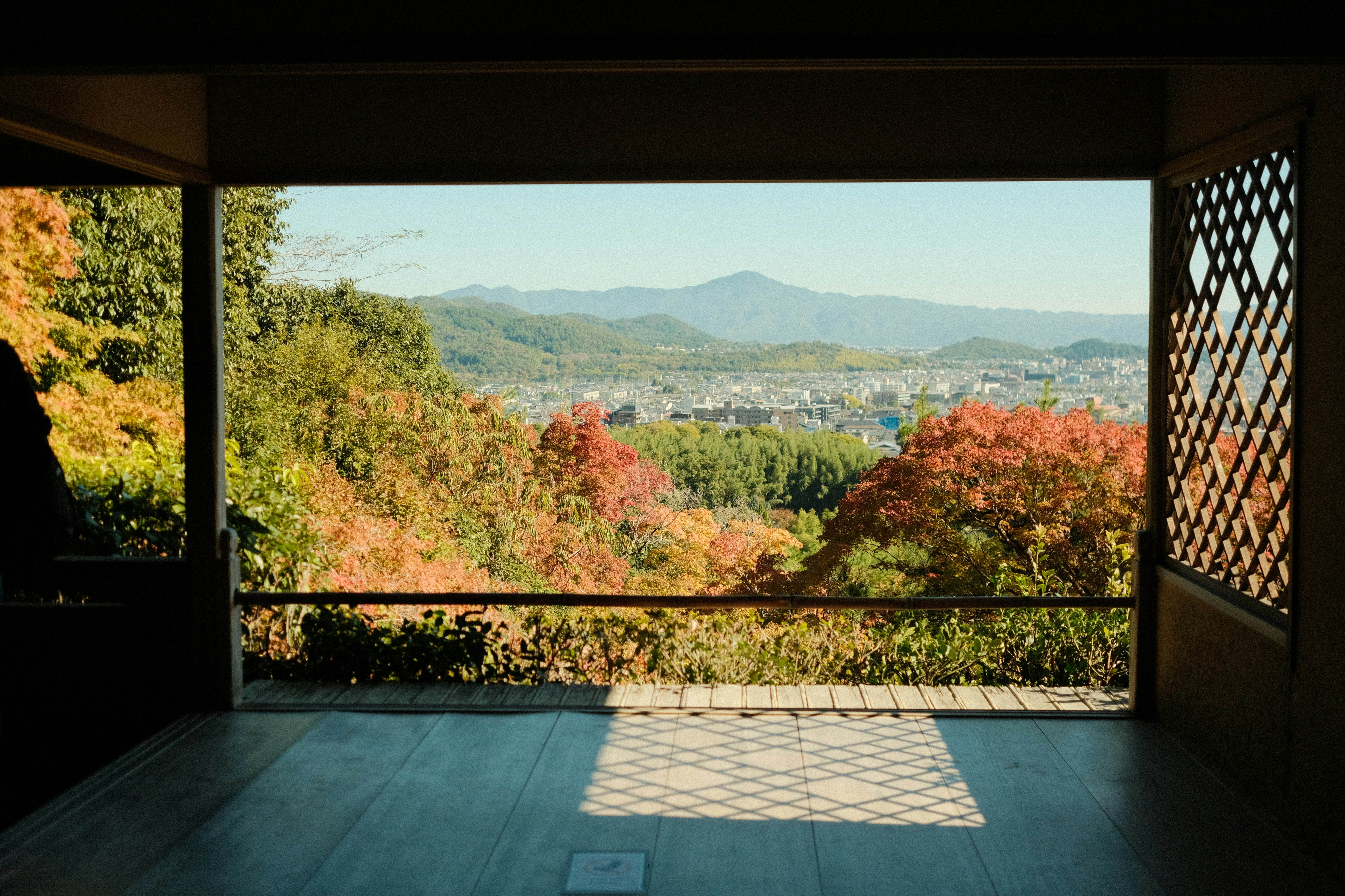 Vibrant autumn landscape and distant town from a traditional room.