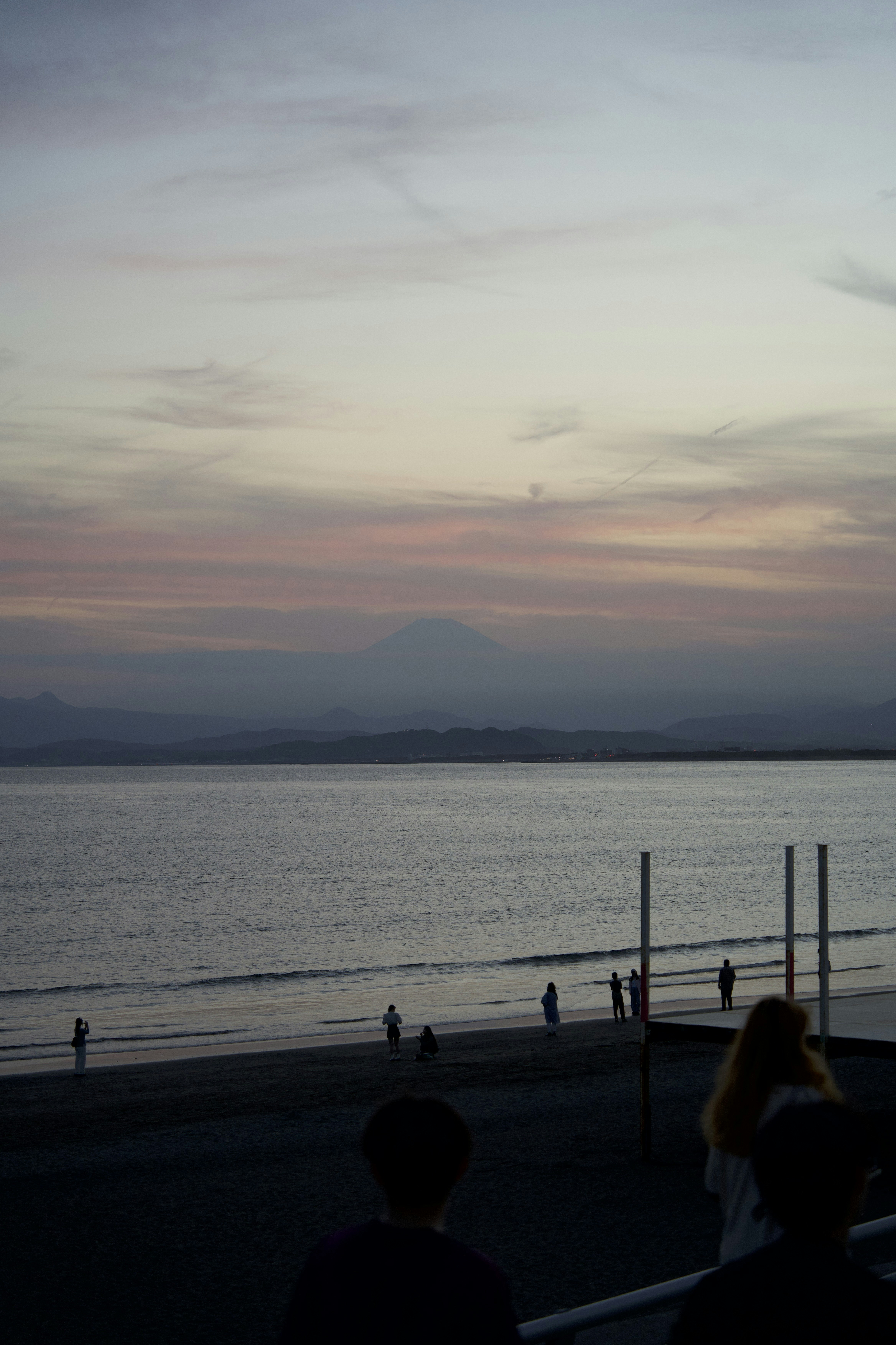 Twilight Shoreline with Distant Volcano Silhouette