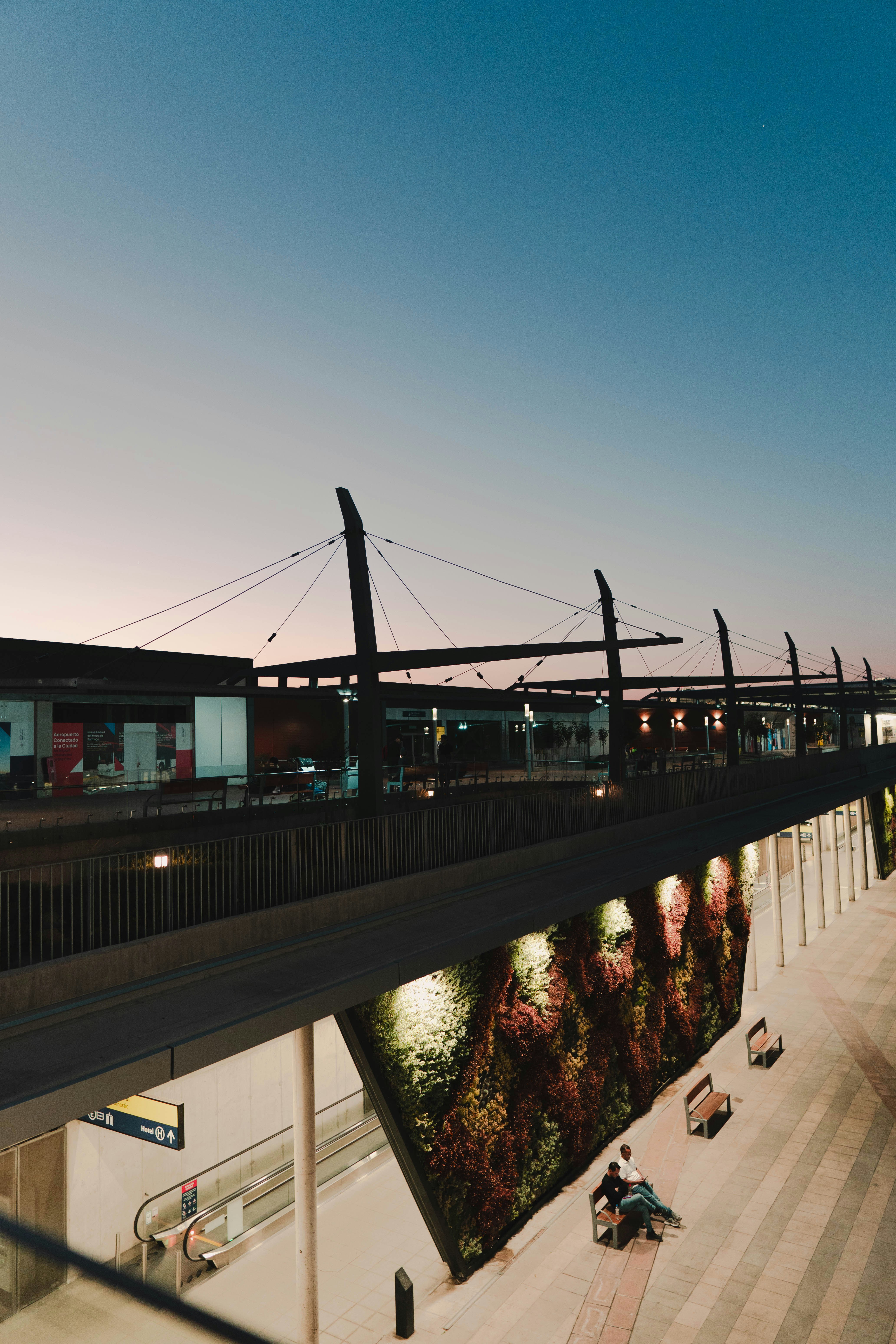 Modern urban complex with a vertical garden at twilight.
