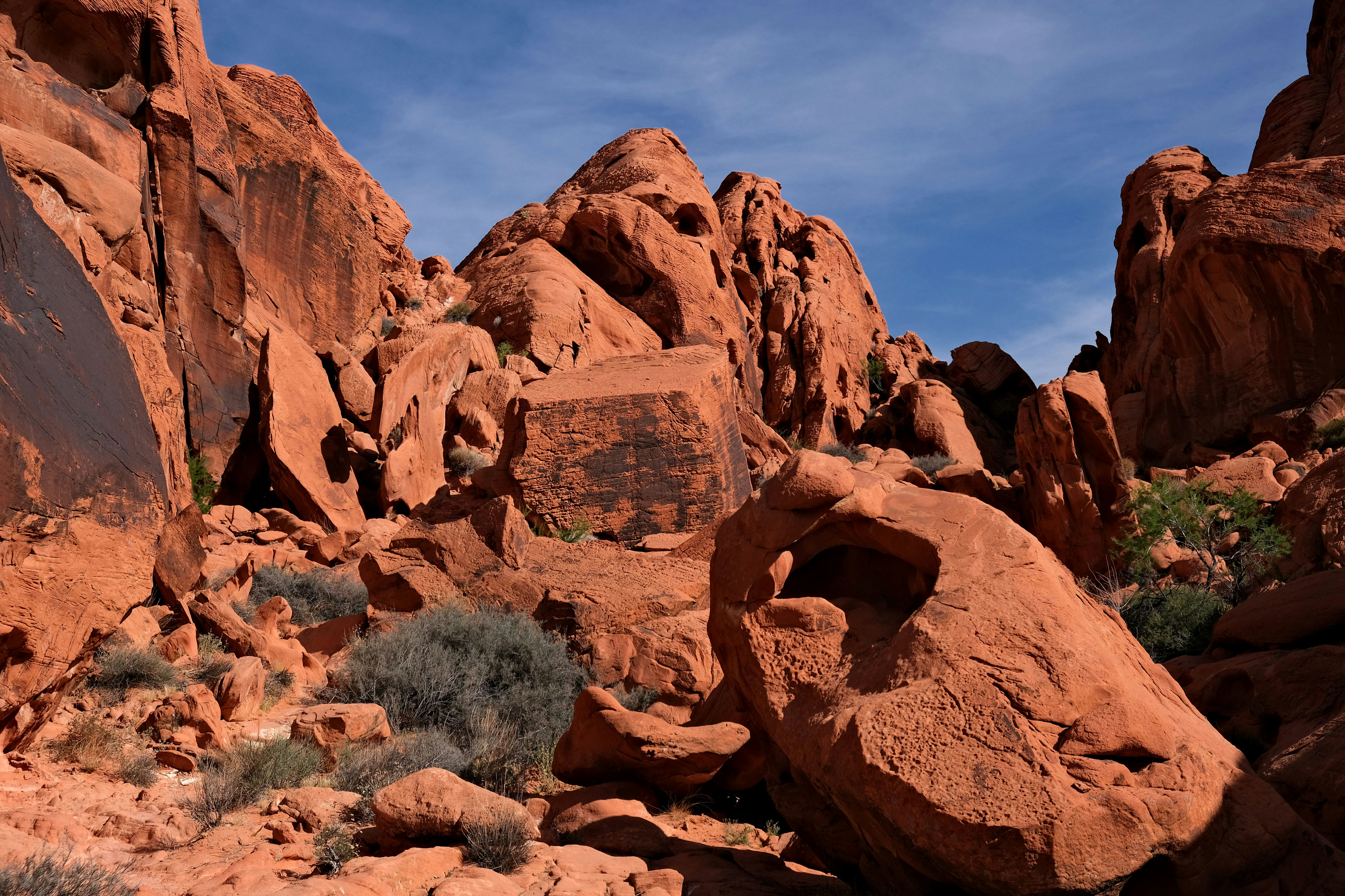 Vast red rock formations under a clear blue desert sky.