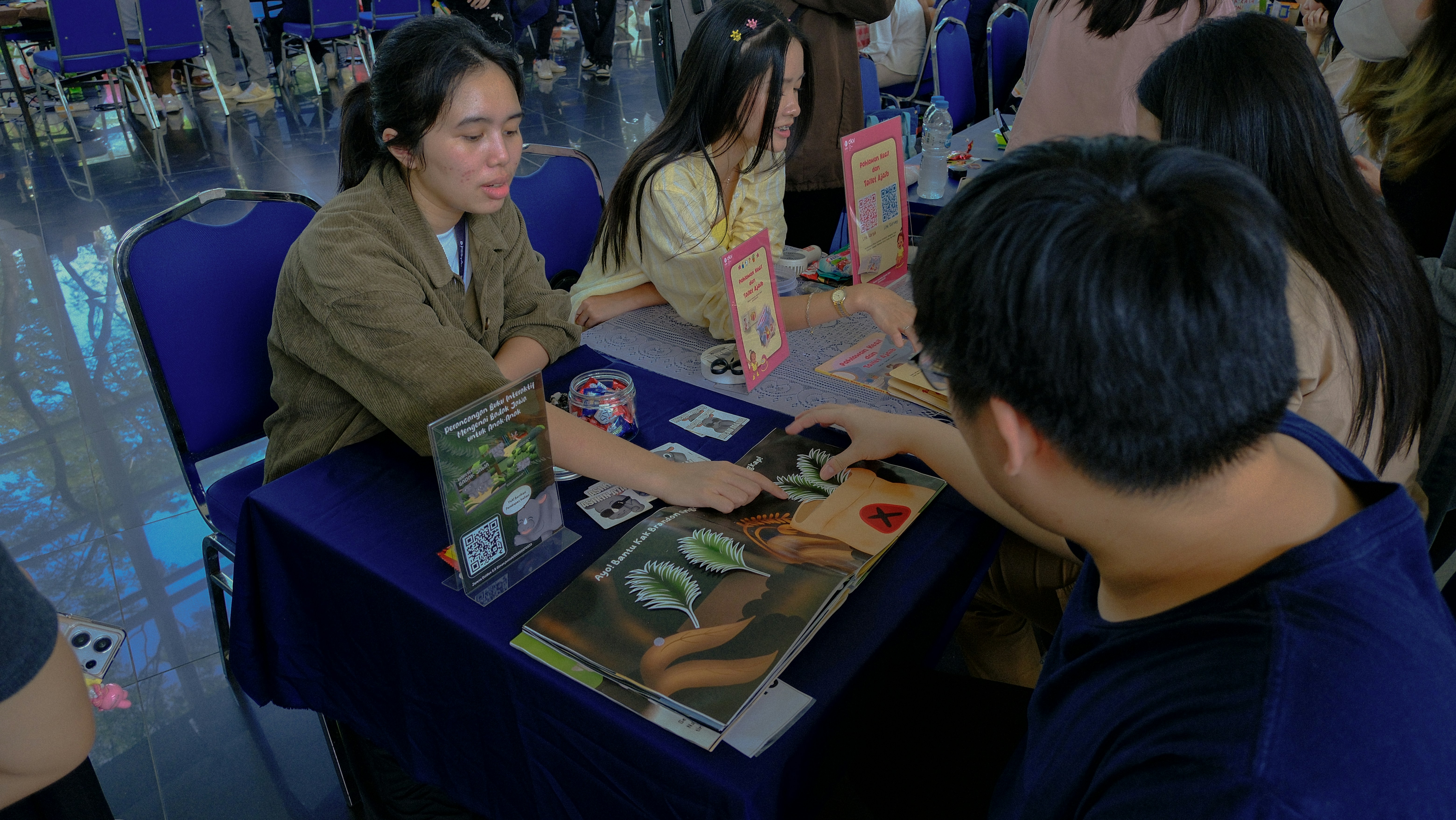 Attendees playing tabletop games at a convention.