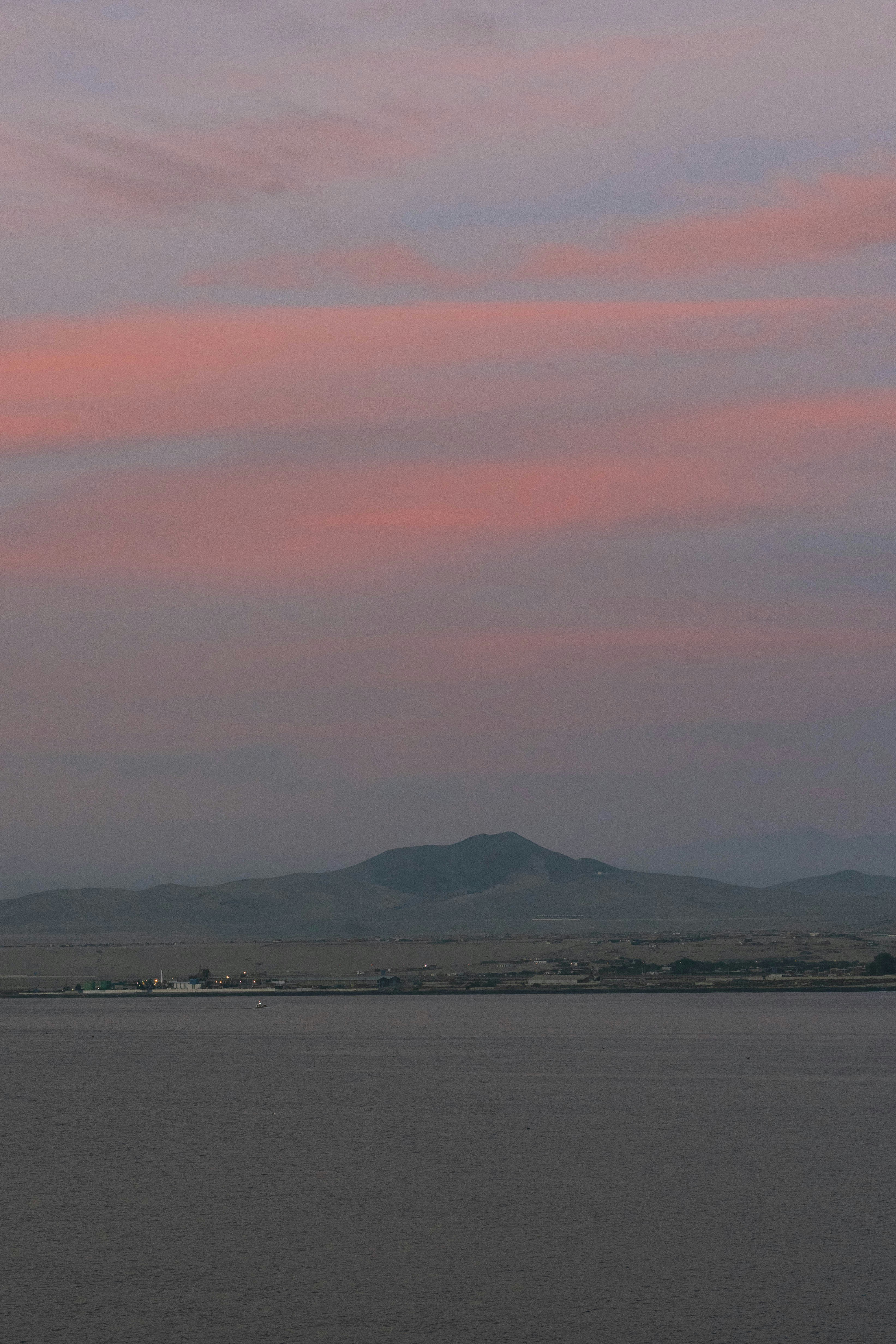 Distant Hills at Sunset Over Quiet Waters