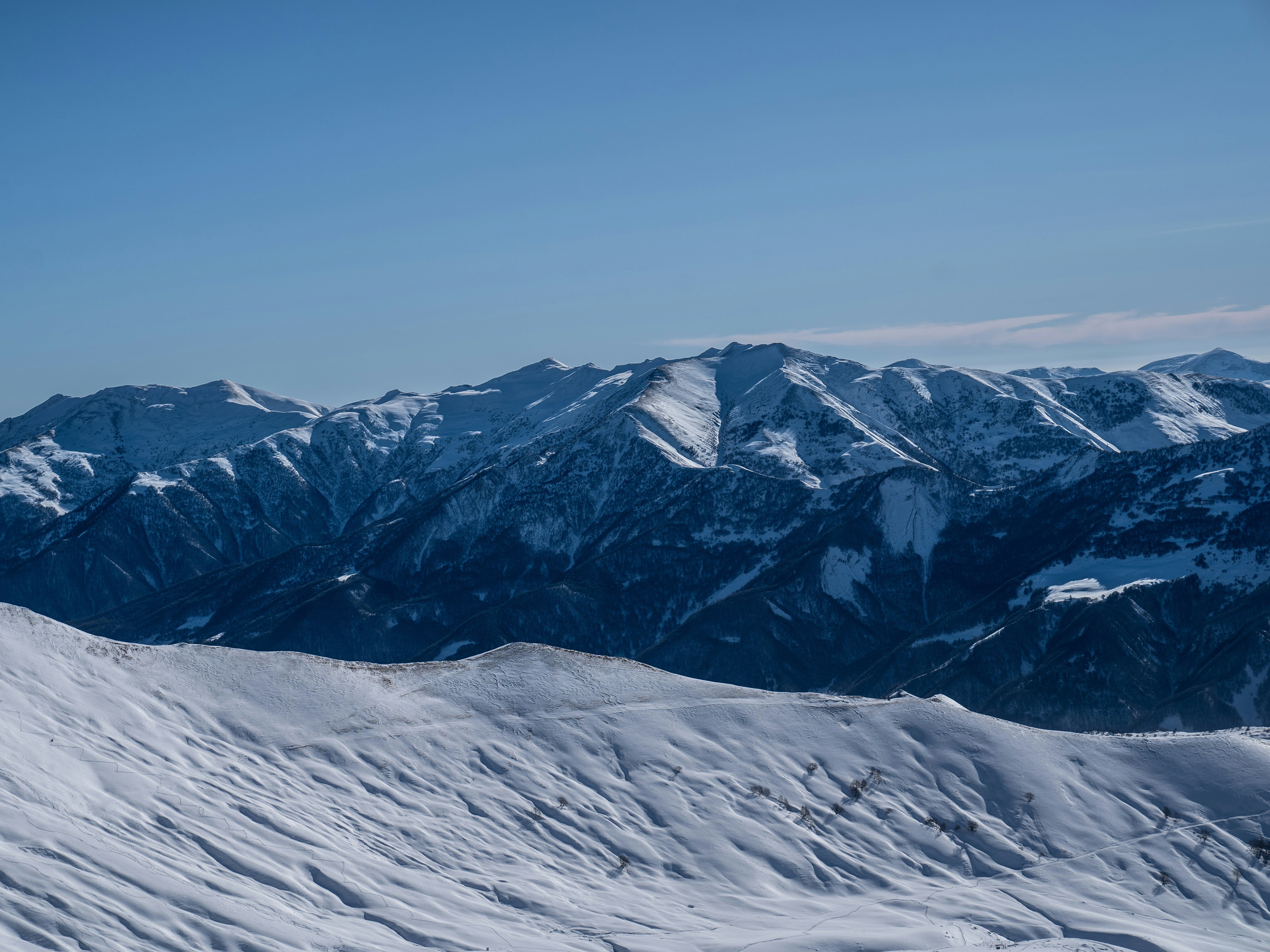 Snow-Kissed Ridge under a Clear Alpine Sky