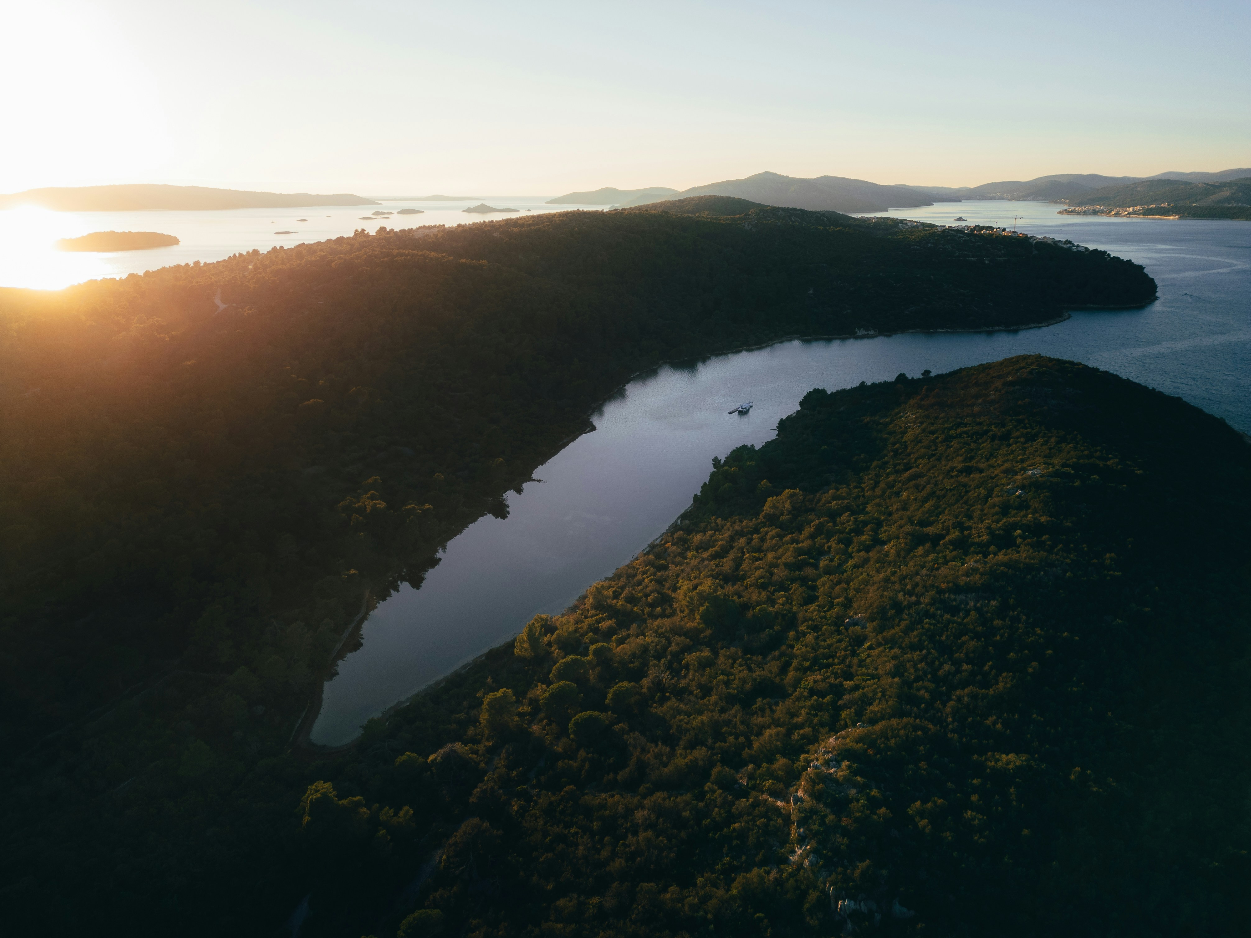 Sun-Kissed Bend: Aerial Dawn Over Serene Waterways