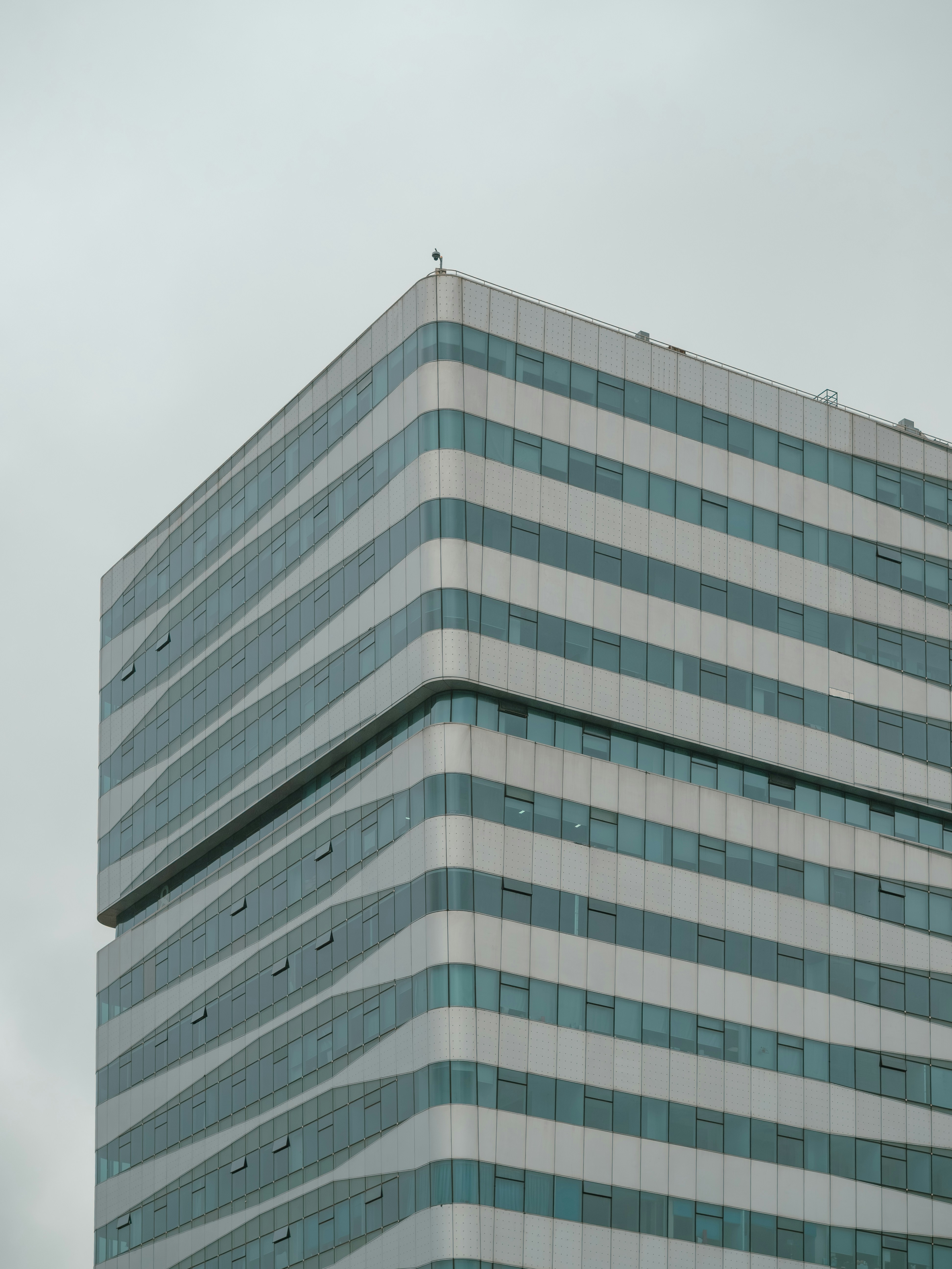 Curved Facade Echoes of Striated Glass