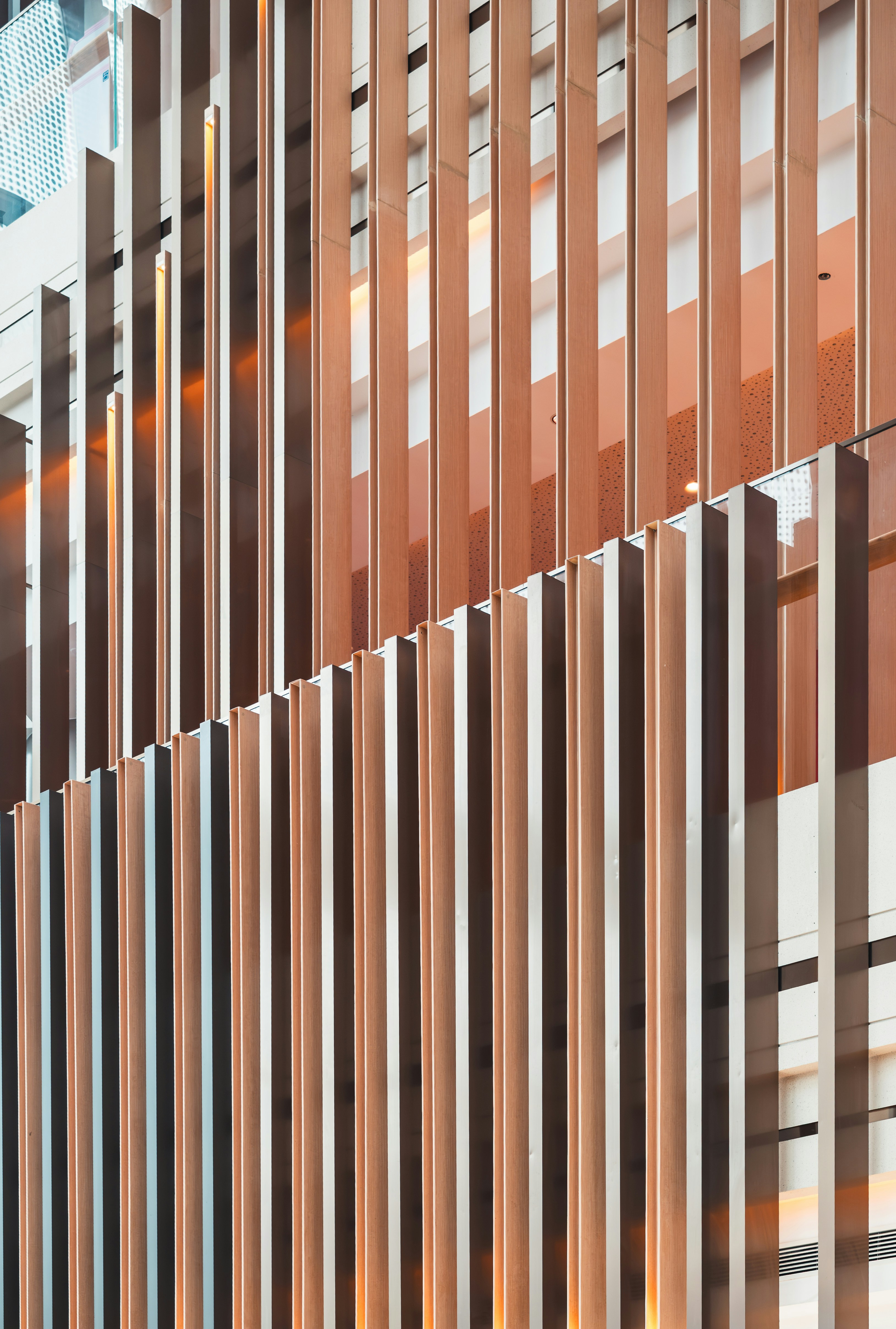 Vertical Golden Facade: Sunlit Strips Reflecting an Urban Rhythm