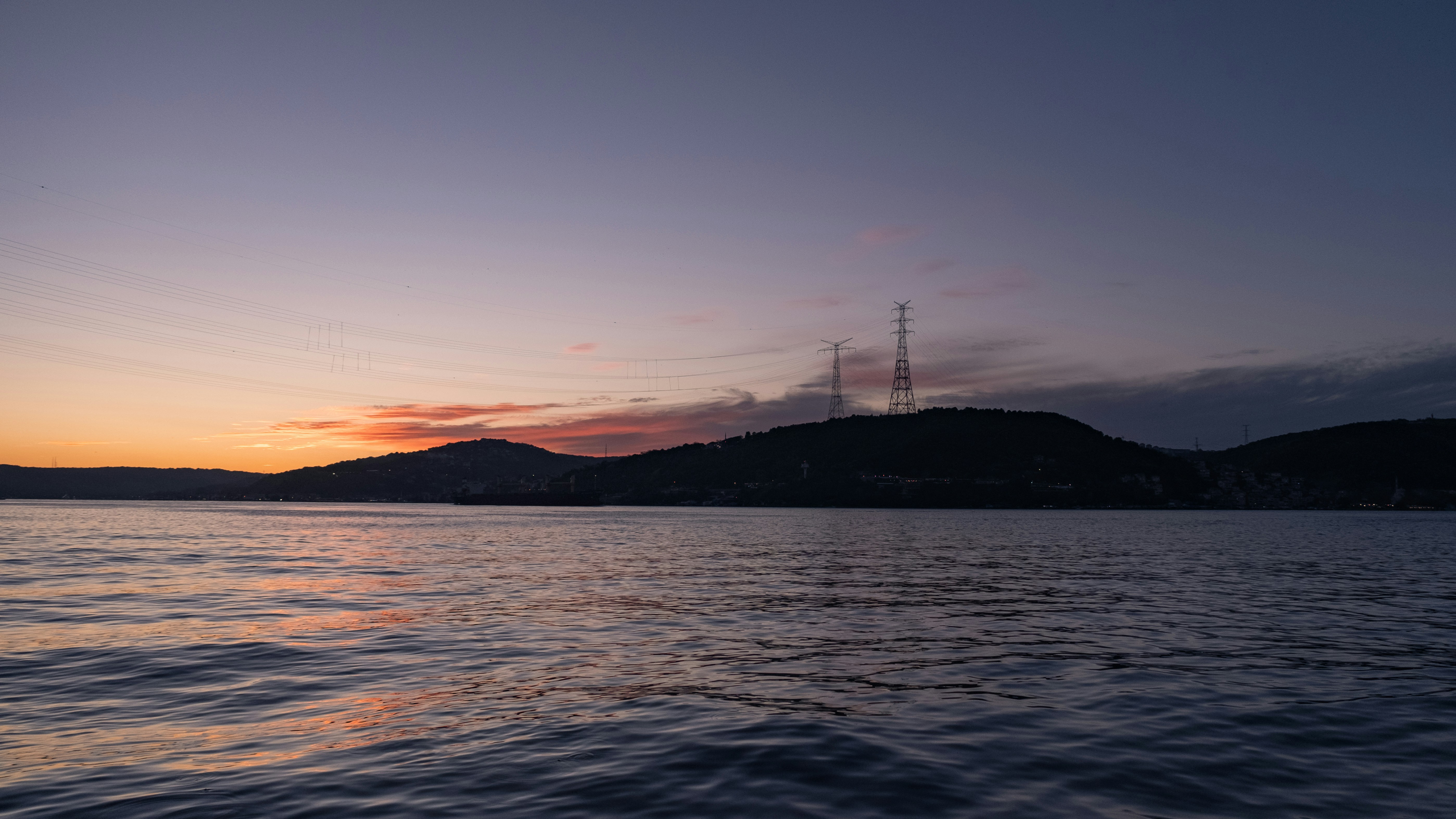 Sunset over a Quiet Lake with Distant Hills