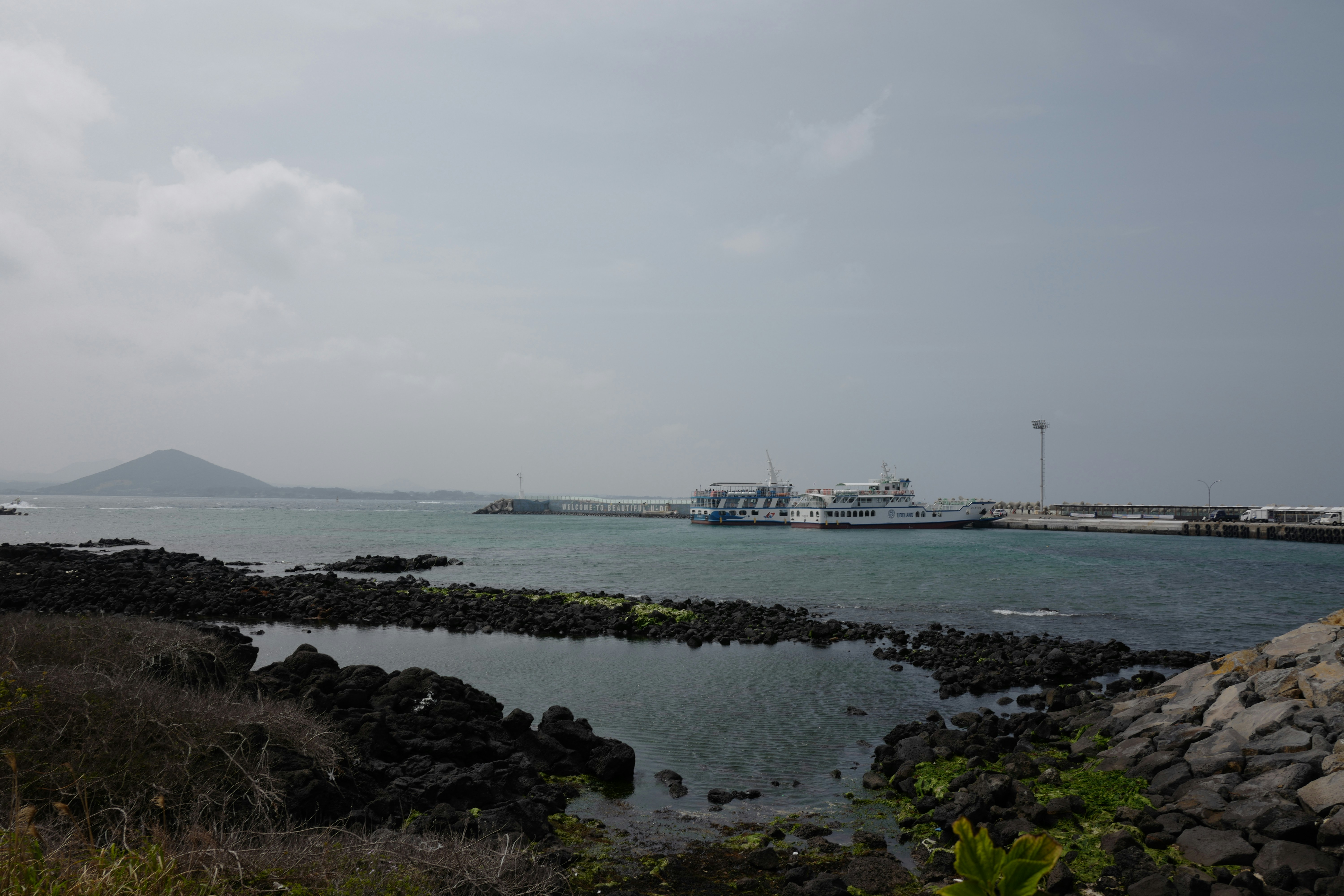 Harbor Wake: Boats at Distant Breakwater
