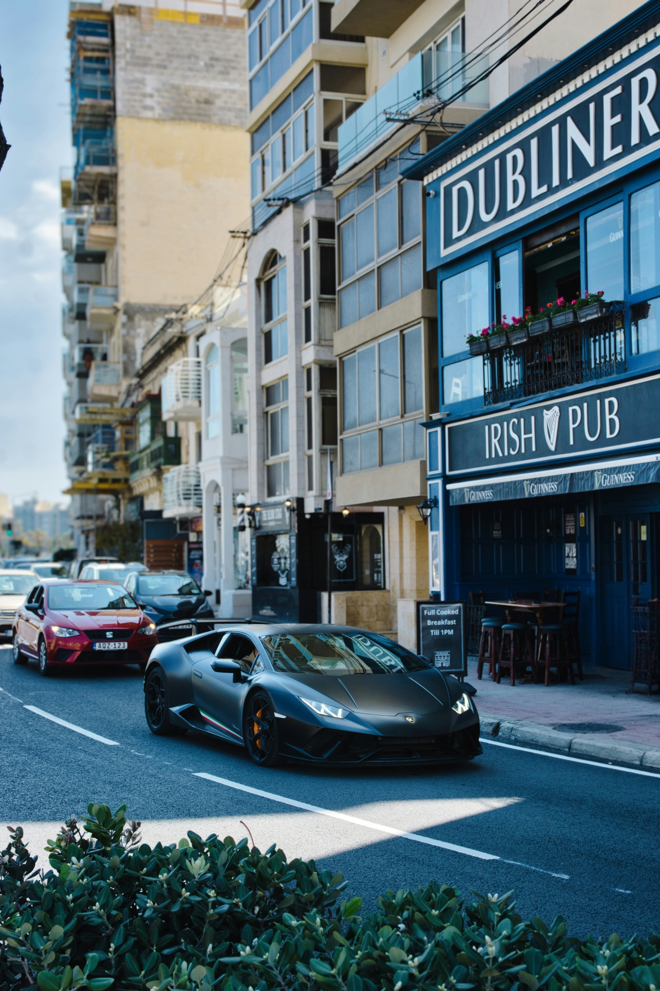 Low Angle, High-Octane: A Matte Black Supercar Leads the Street into Dublin's Pub District