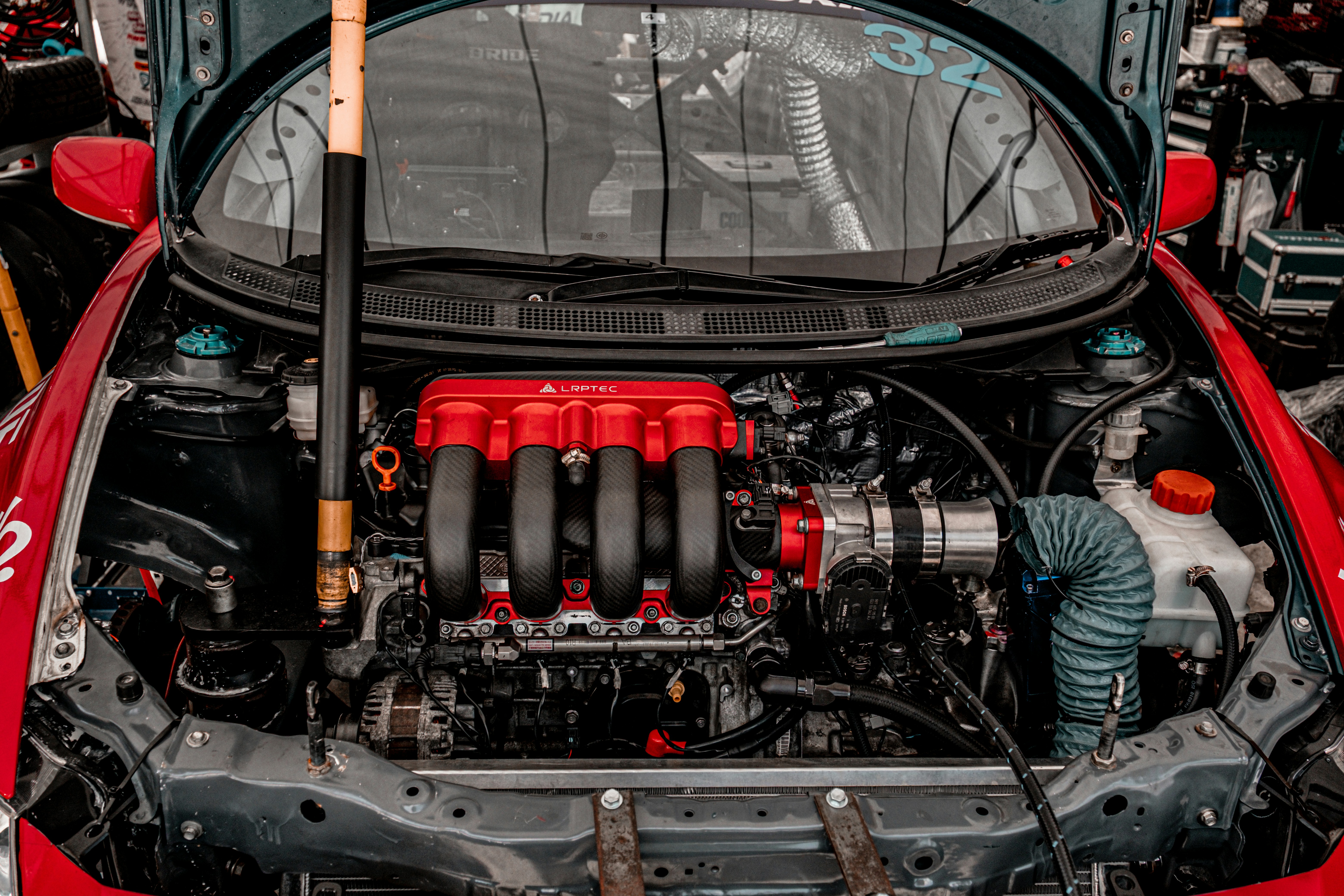 Red Turbocharged Heartbeat: A Front-Row View of a Car Engine