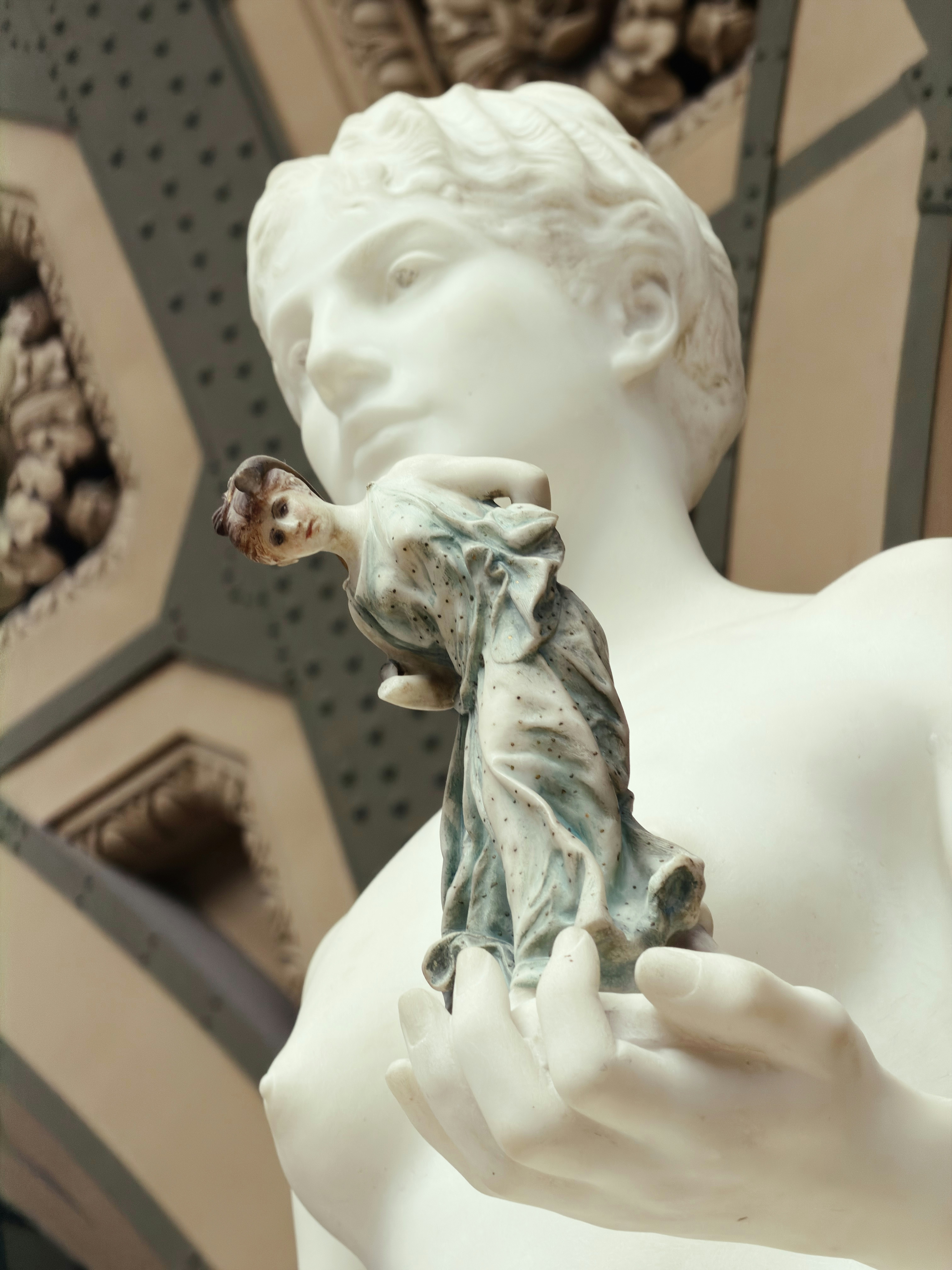 Statue Portrait: A Tiny Figure Graced by a Giant Hand