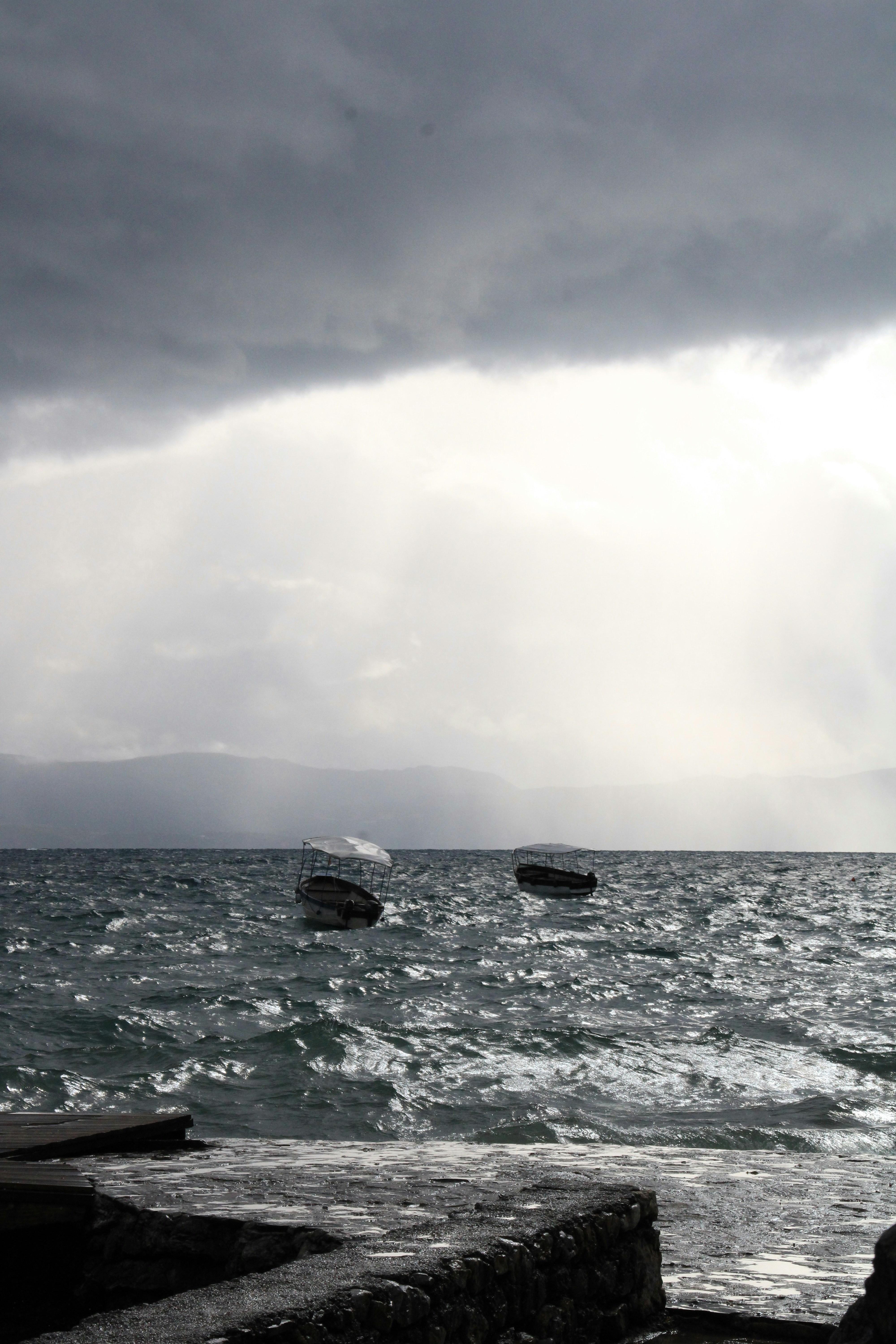Stormy Sea Silhouettes Between Sunbeams