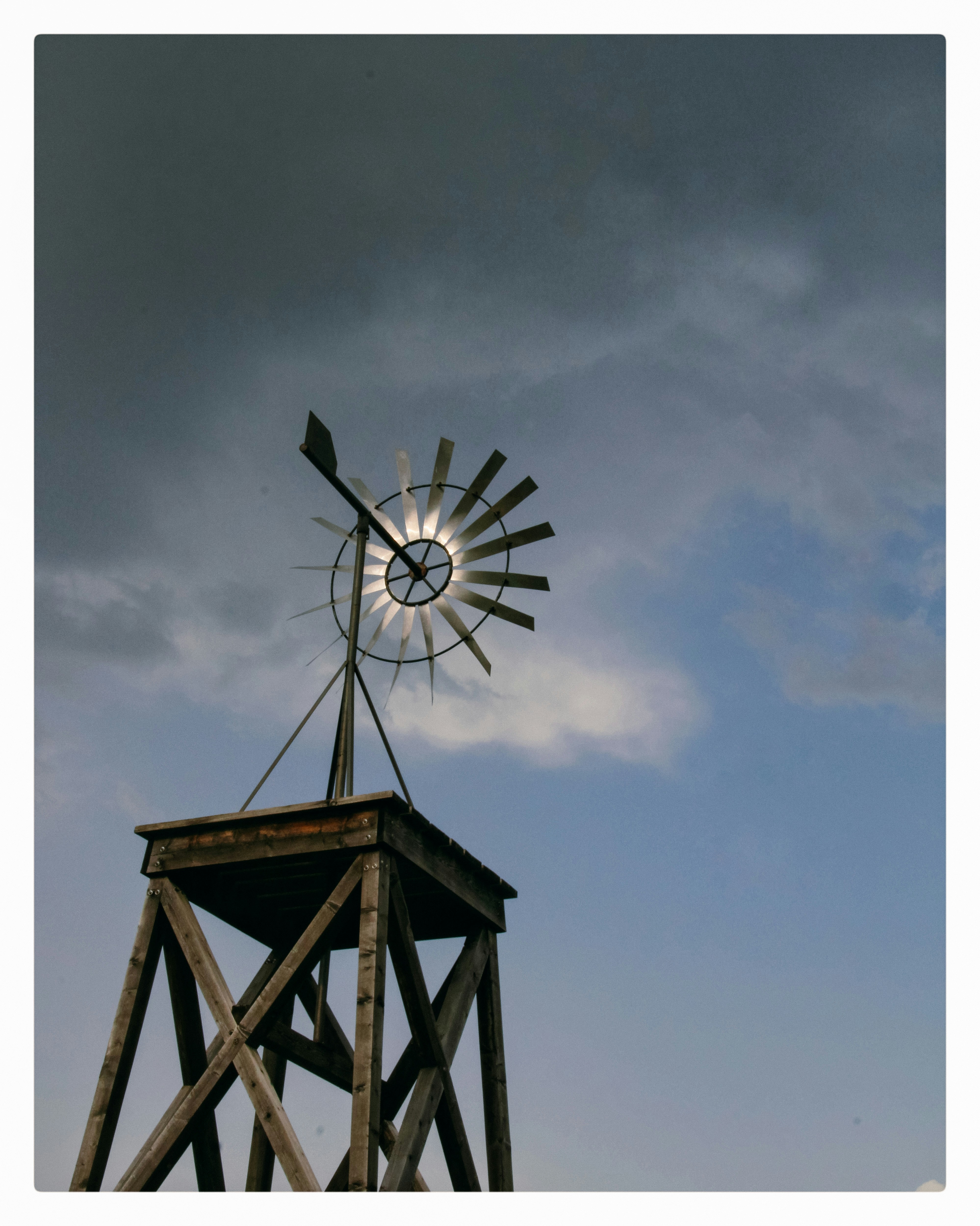 Windmill Spotlight: A Rustic Tower Against a Quiet Sky