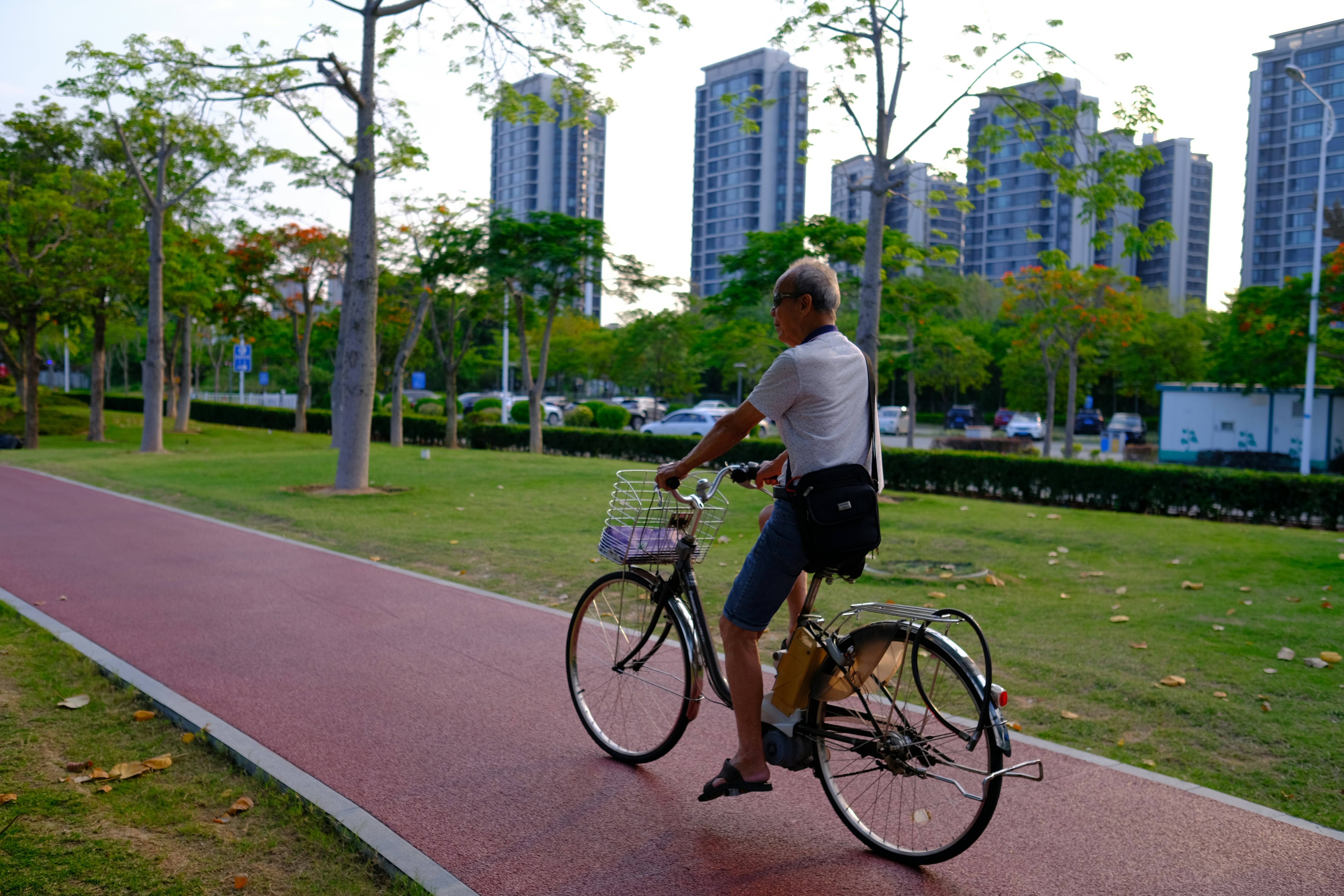 Rider at Rest: City Park Transit on a Sunset-Spiked Path