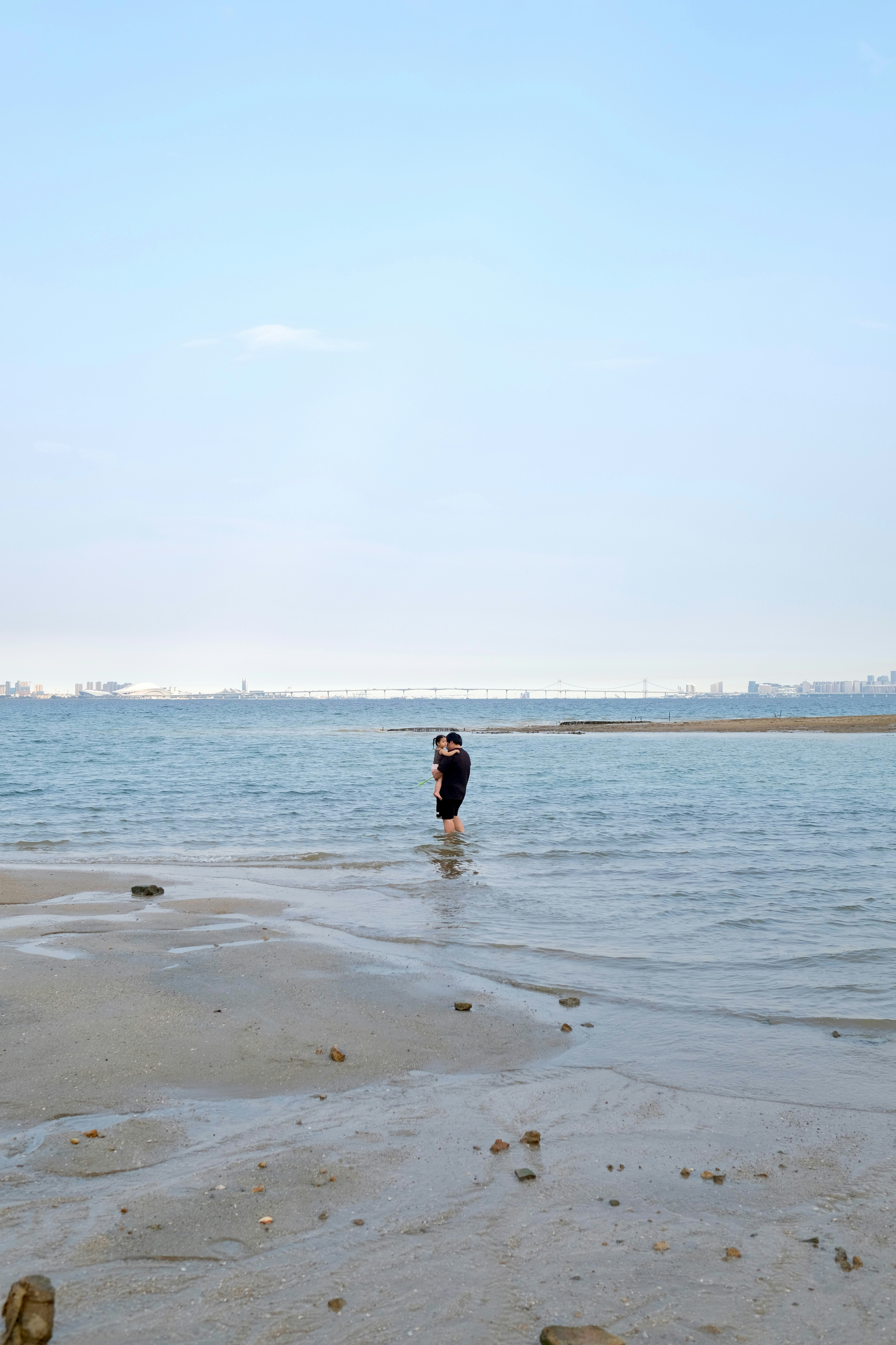 Seaside Embrace: A Quiet Moment in Shallow Tides