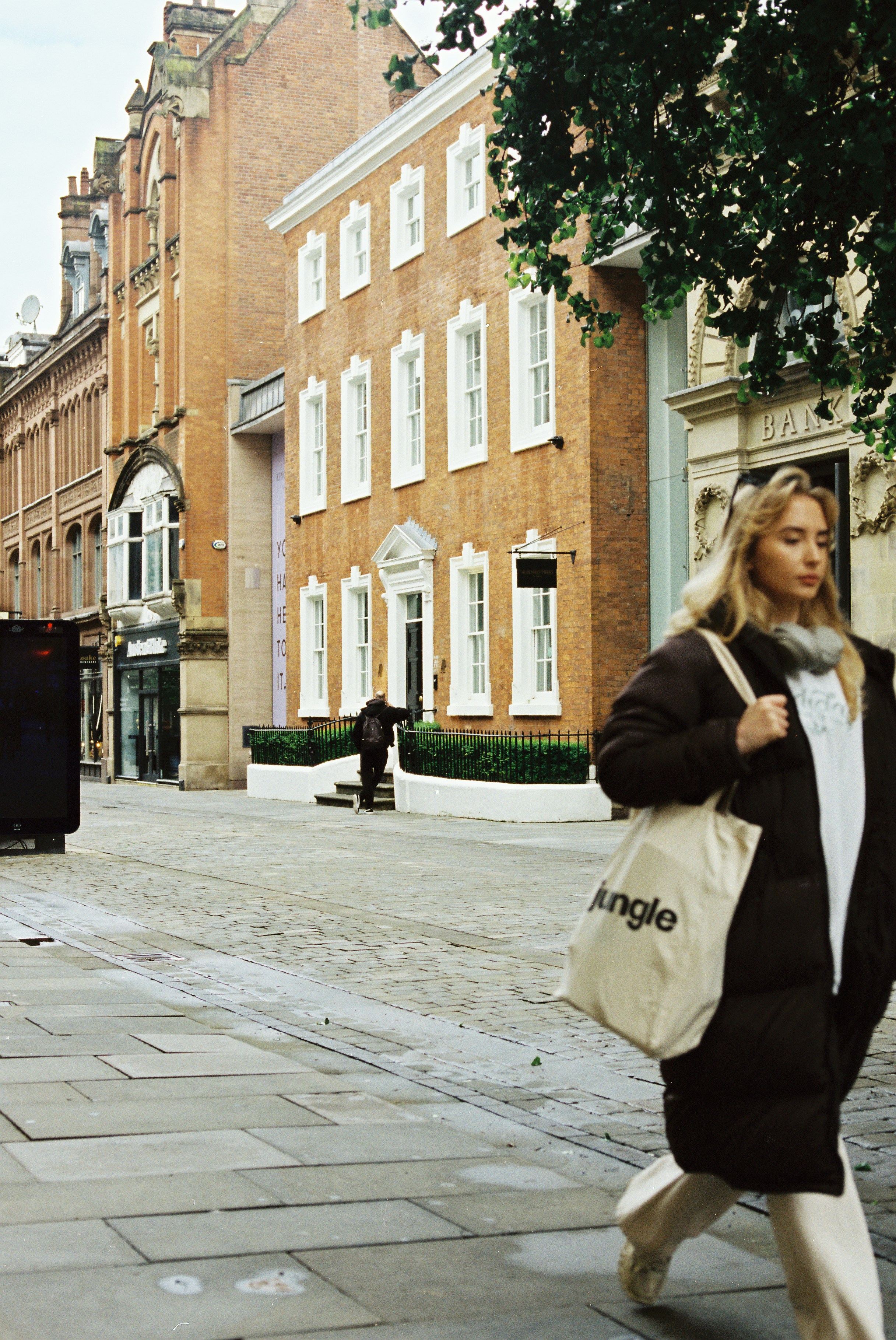 A Street Scene with a Blurred Passerby and Classic Georgian Facades