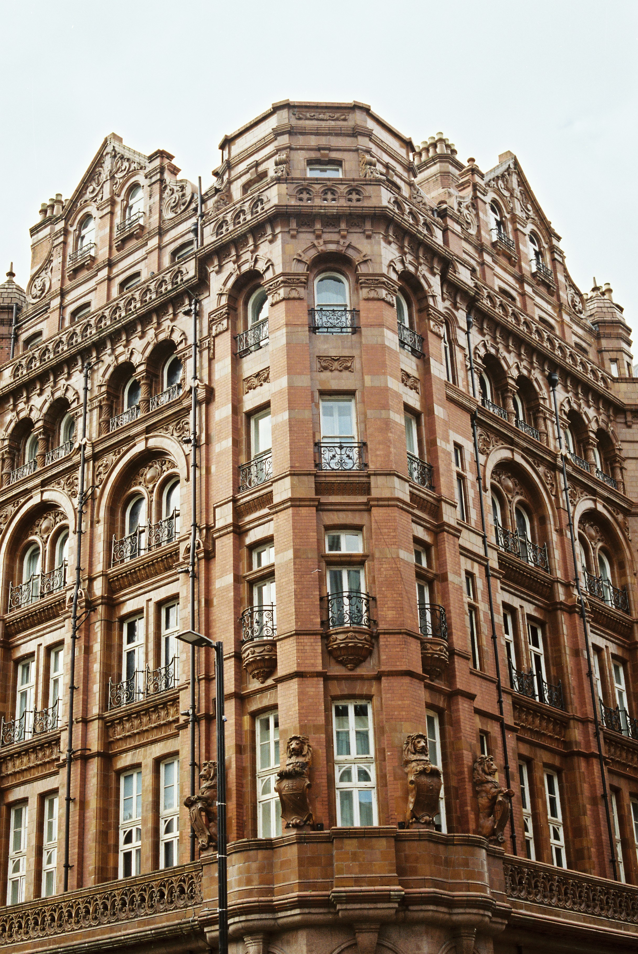 Gothic Red Brick Facade: A Corner Clockwork of Stone and Steel