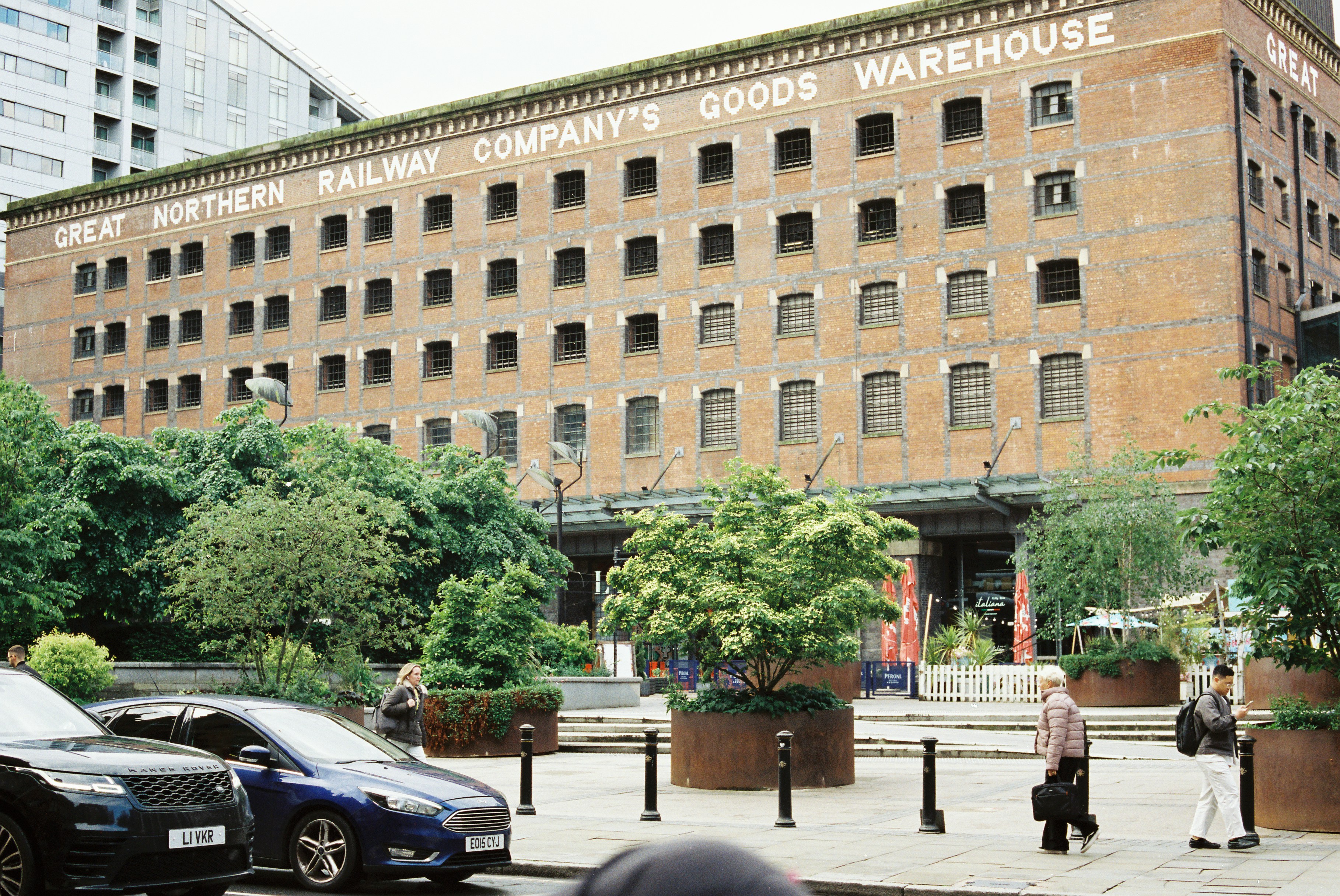 Brick Warehouse, Urban Activity, and Greenery as Frame