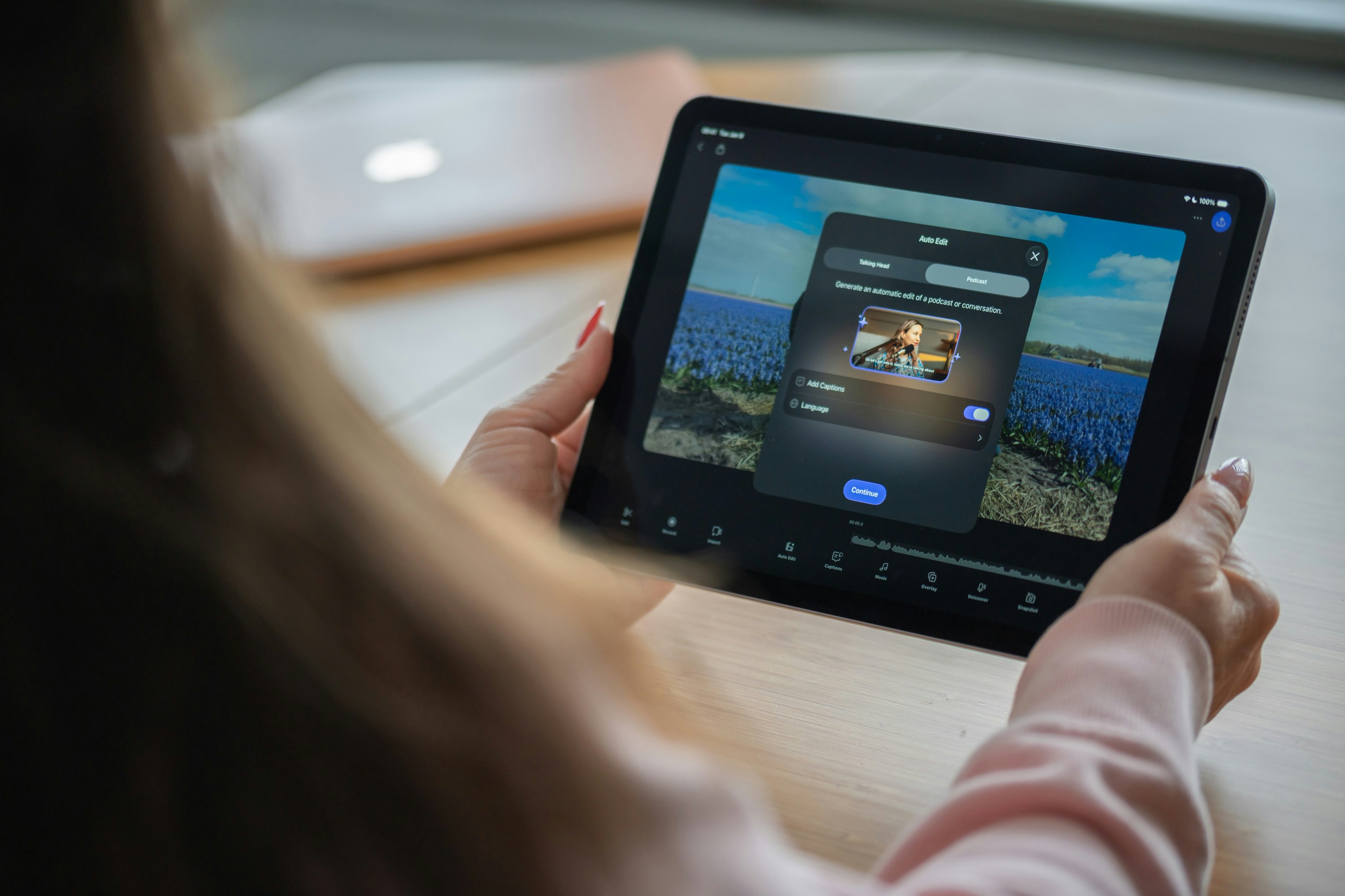Tablet interface on a seated user viewing a photo editing app outdoors