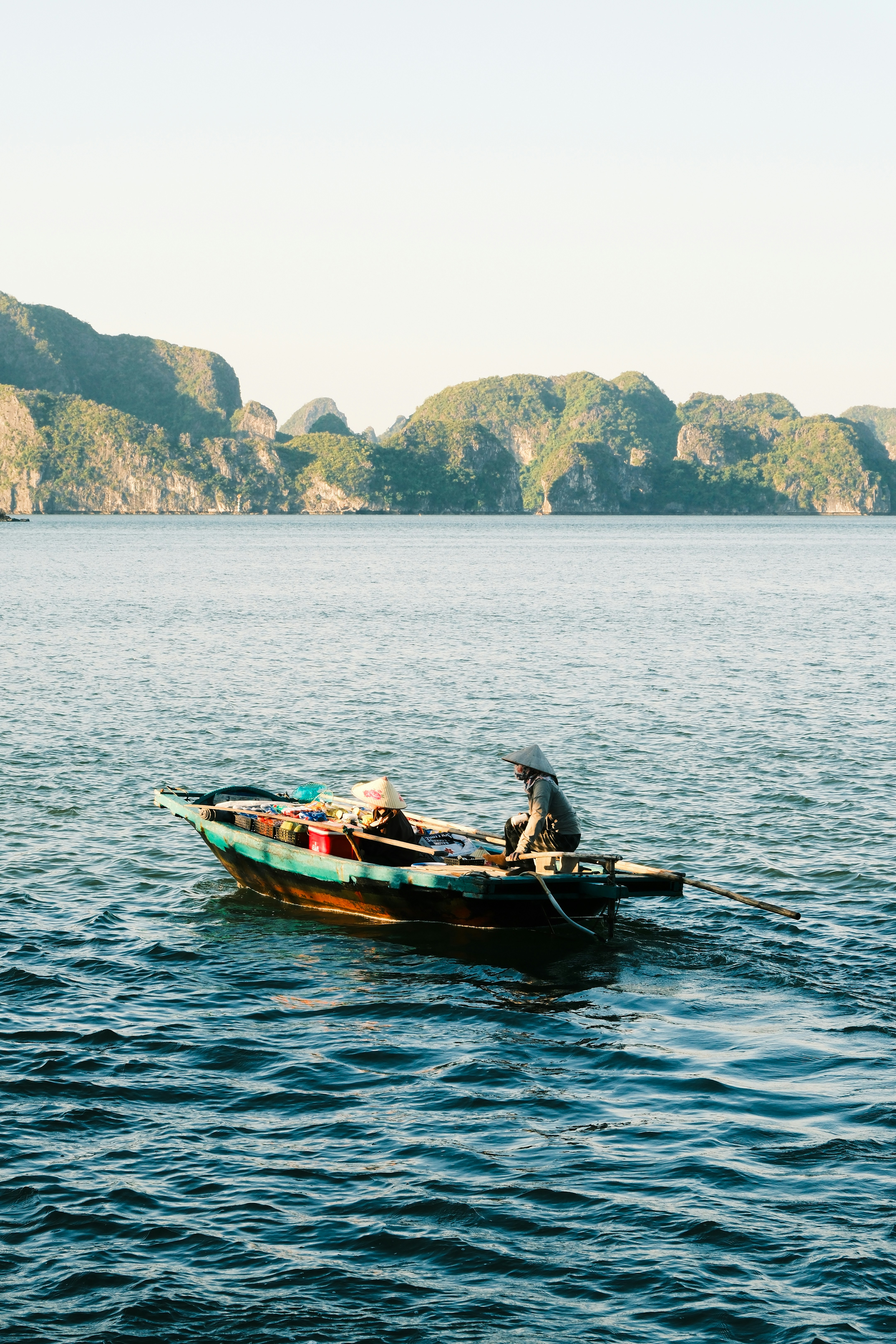 Boat at Sea: A Quiet Crossing Under Limestone Islands