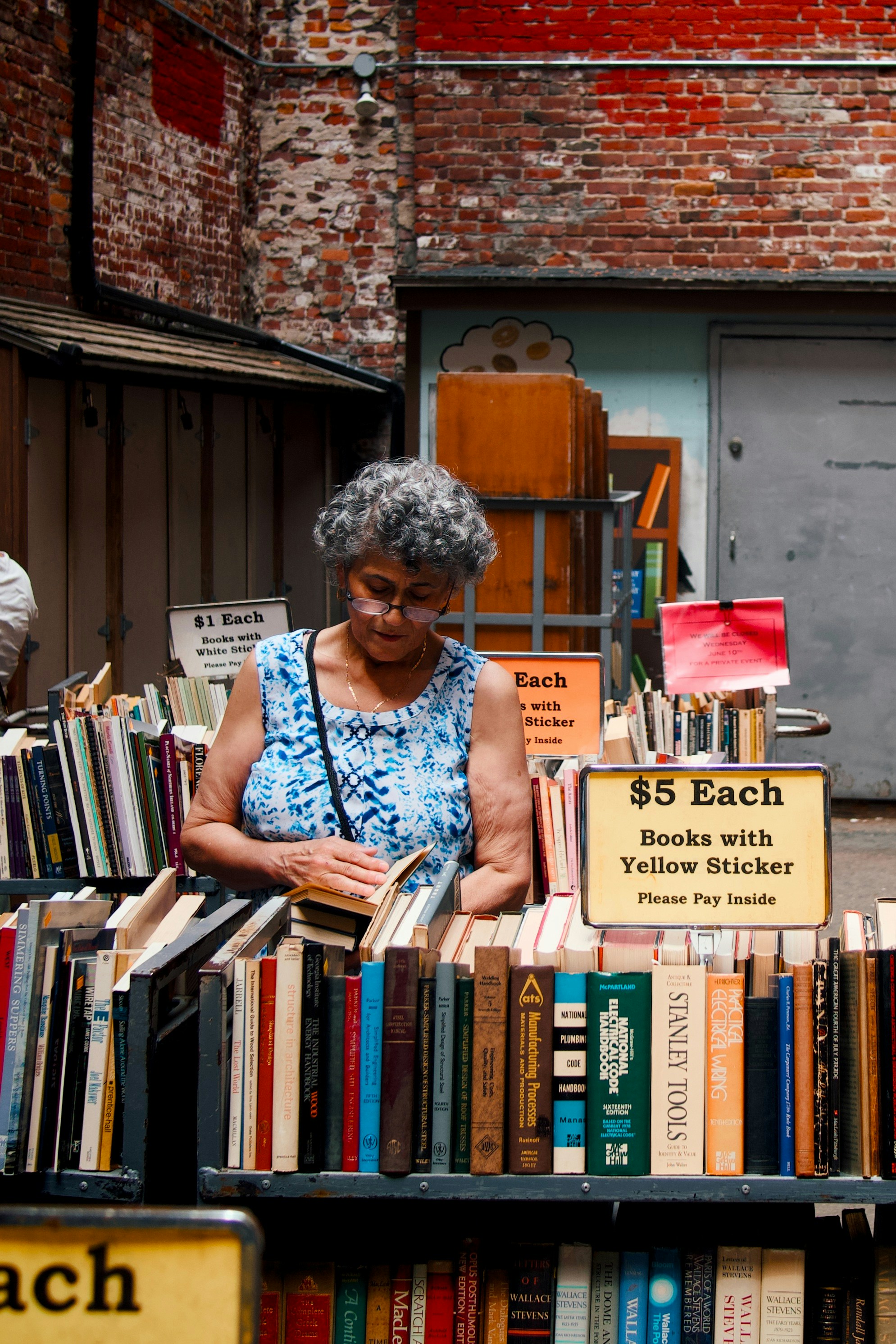 Bookseller in a Public Pantry: A Quiet Moment Amid Stacked Stories