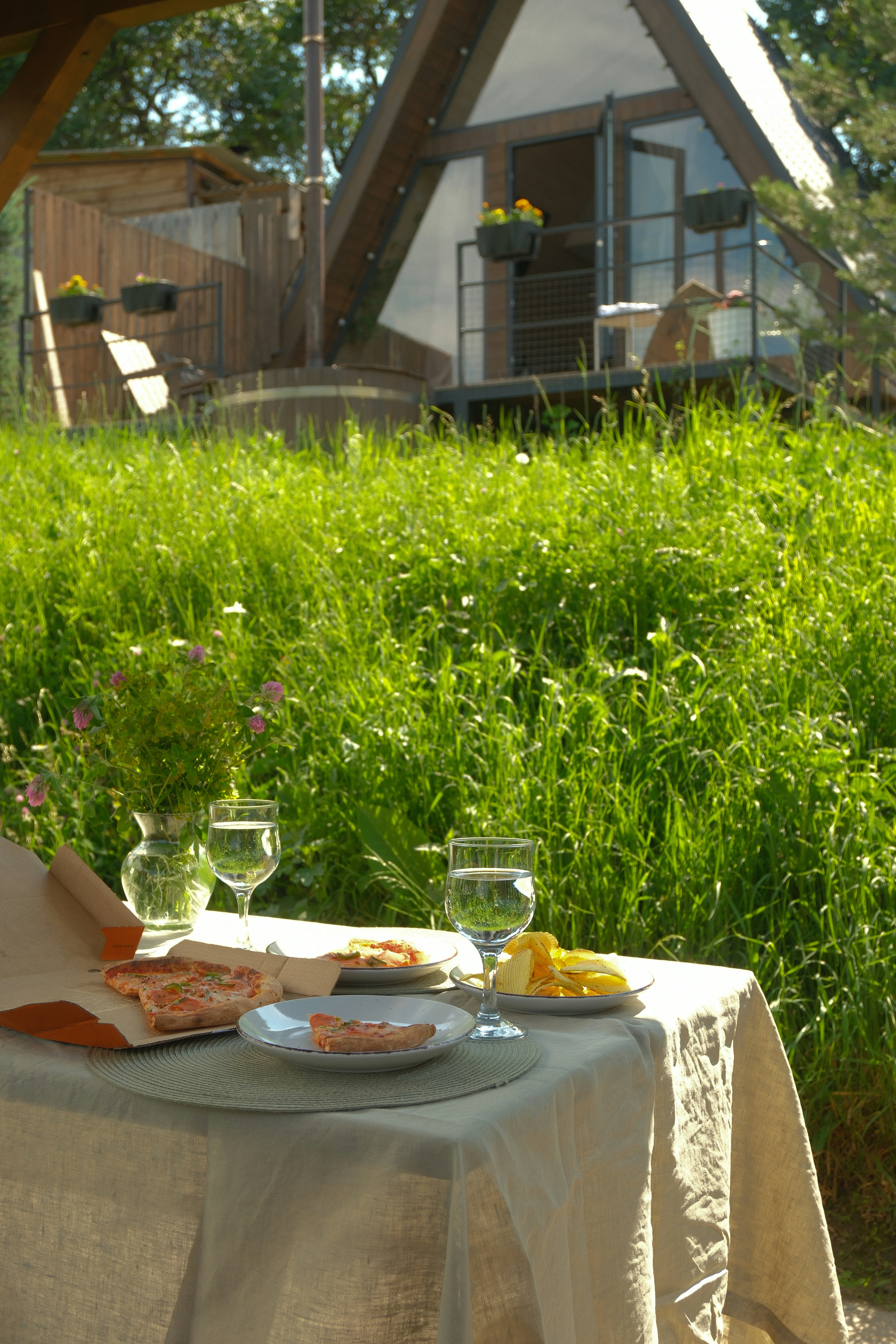 Al fresco dining with an a-frame house in the background.
