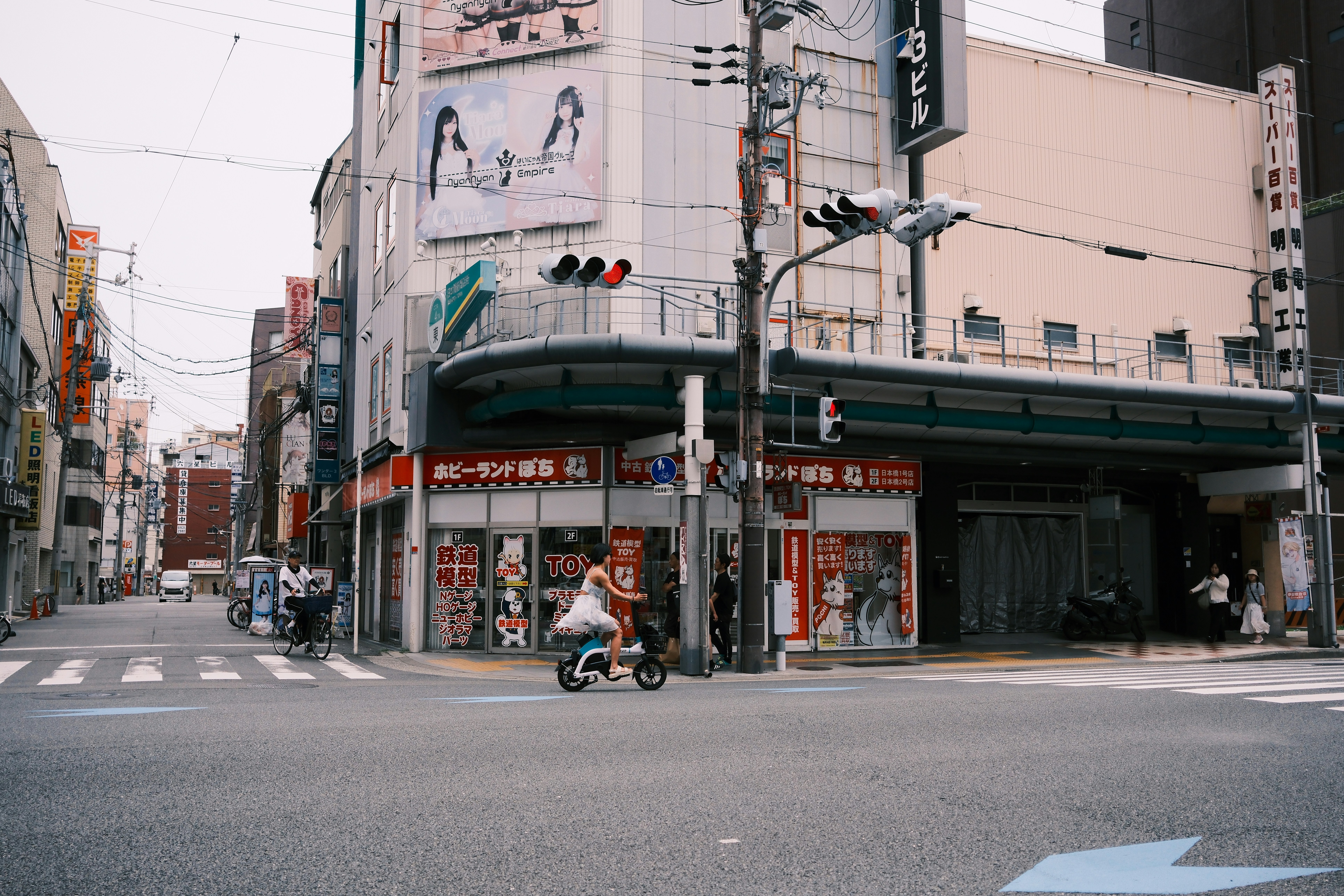 Crosswalk Calm: A Rider Pauses at a Busy Japanese Corner