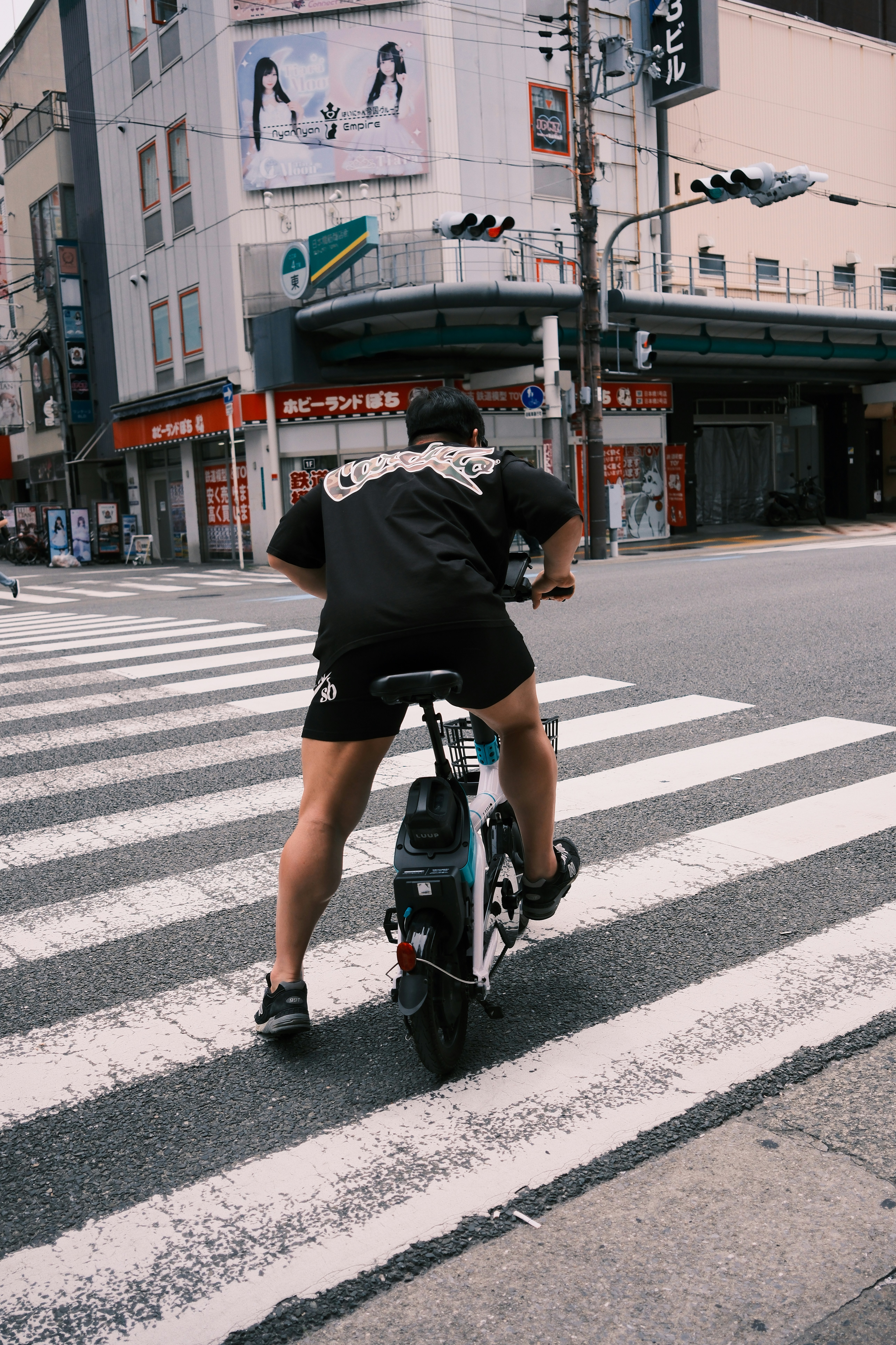 Rider Narrowly Crosses the City Line on a Quiet Block