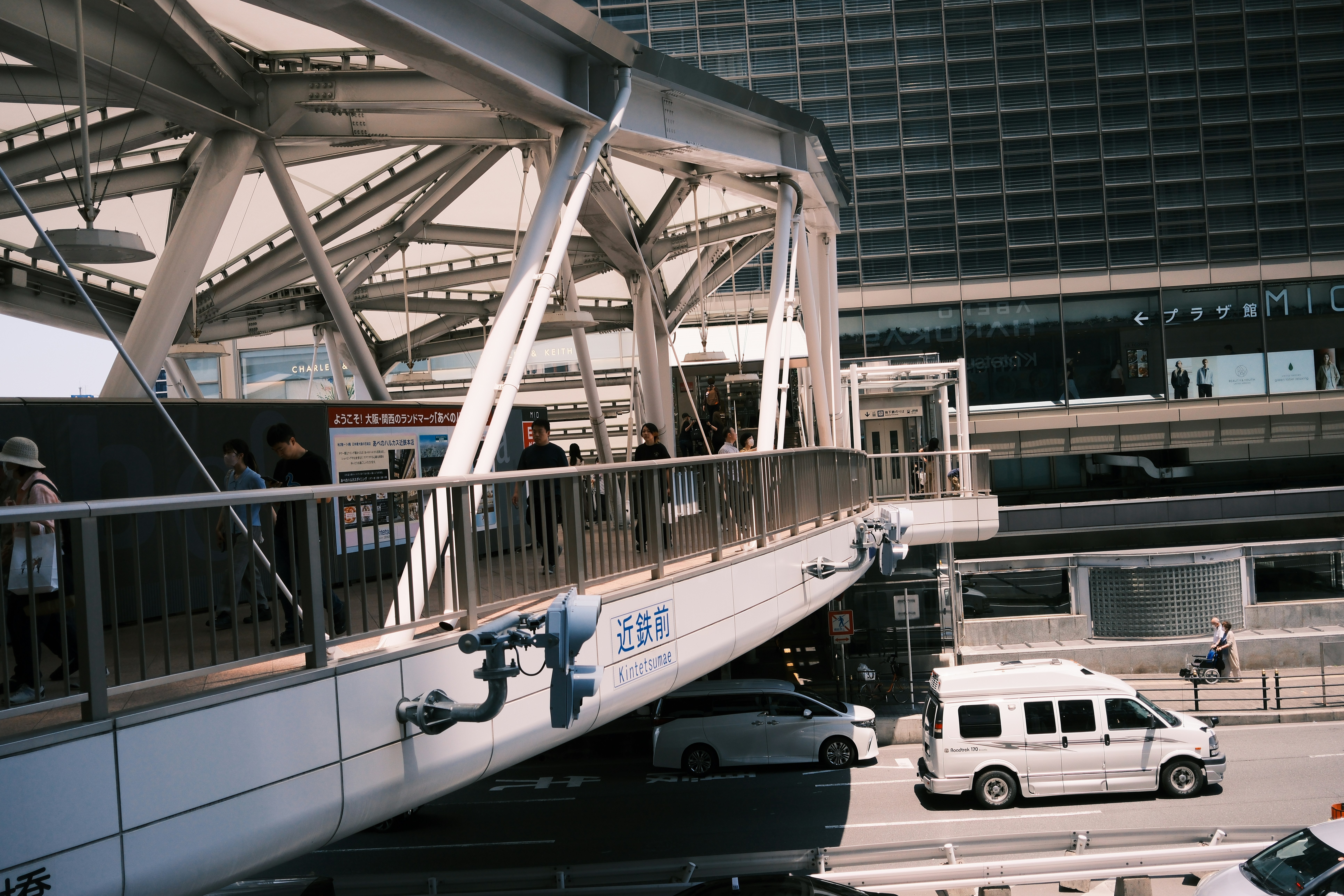 Glass-and-steel Footbridge Over a Busy City Street