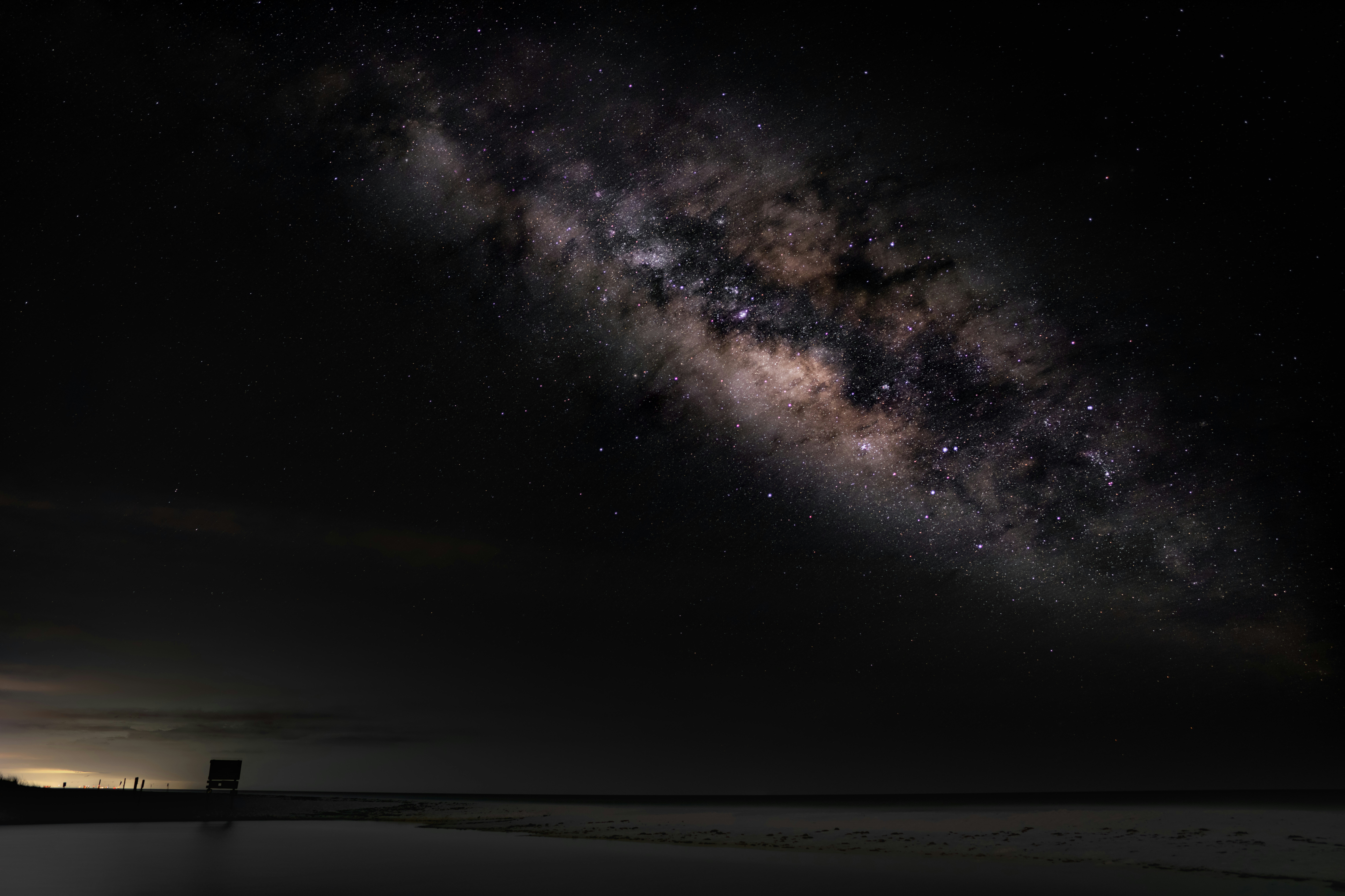 Beneath a quiet coastal sky, the Milky Way stretches across the darkness like a river of light.