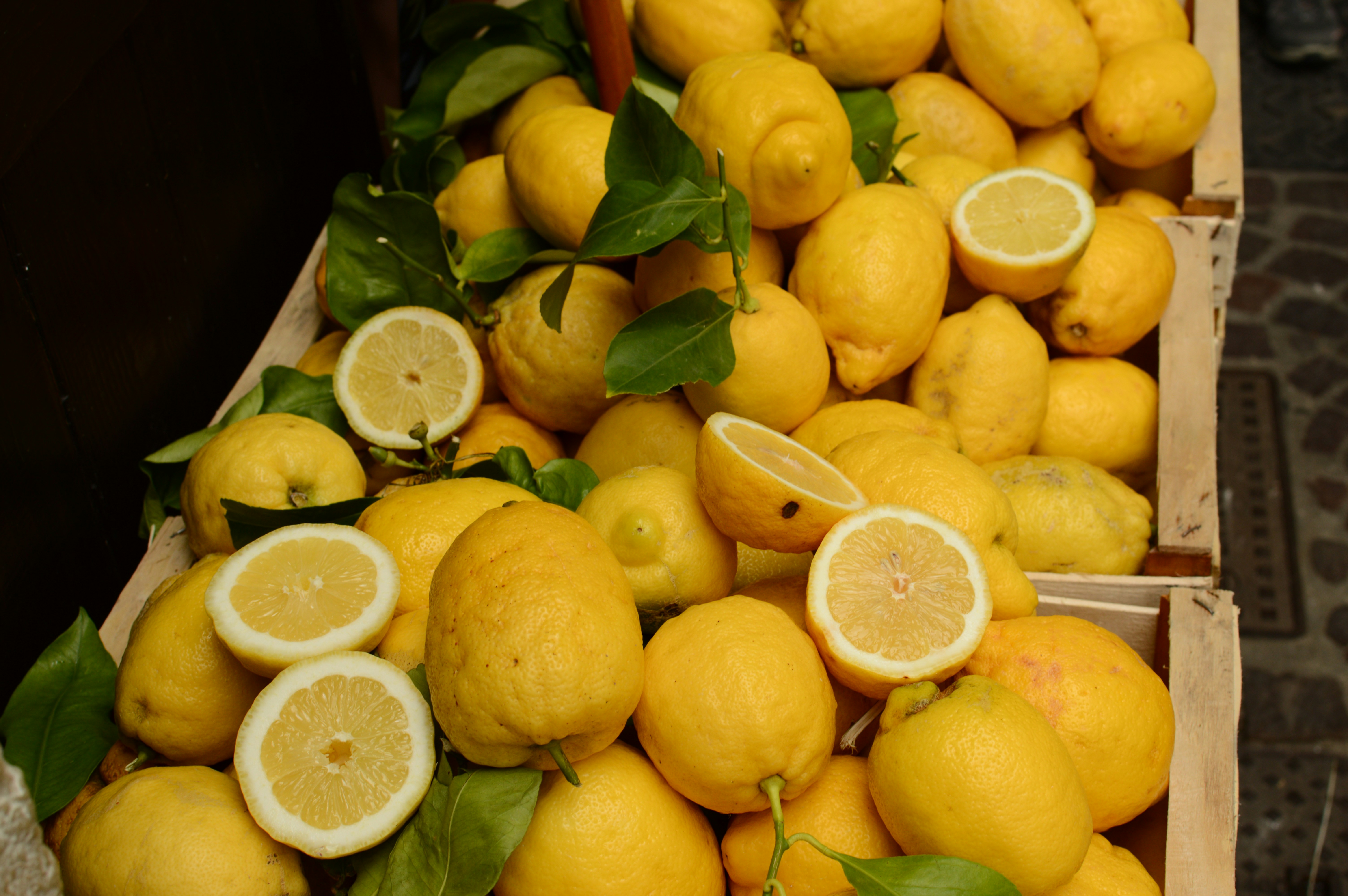 Lemon bounty: a crate of sun-bright citrus at market edge