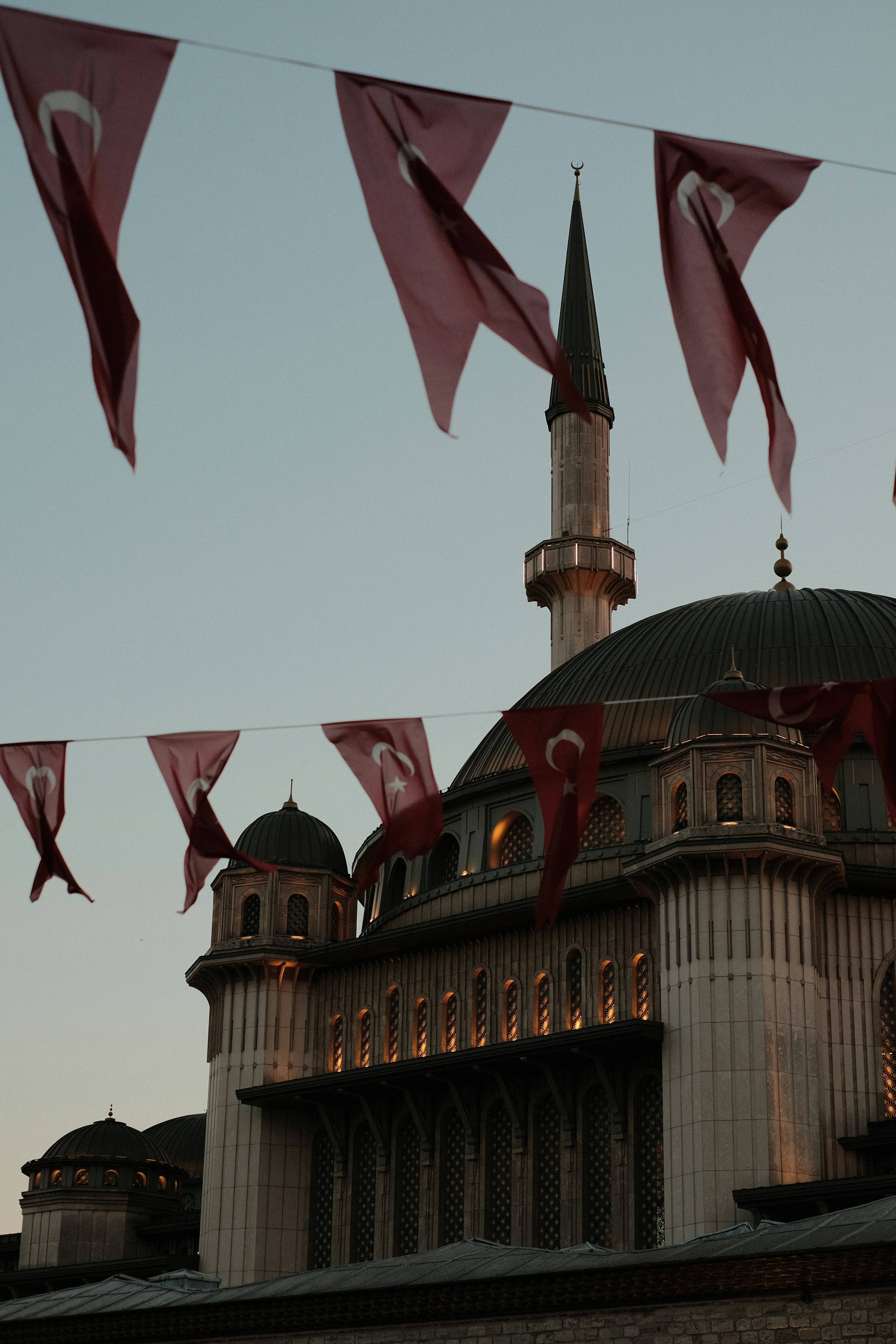 Flags in the Breeze Over a Dome-Minareted Mosque