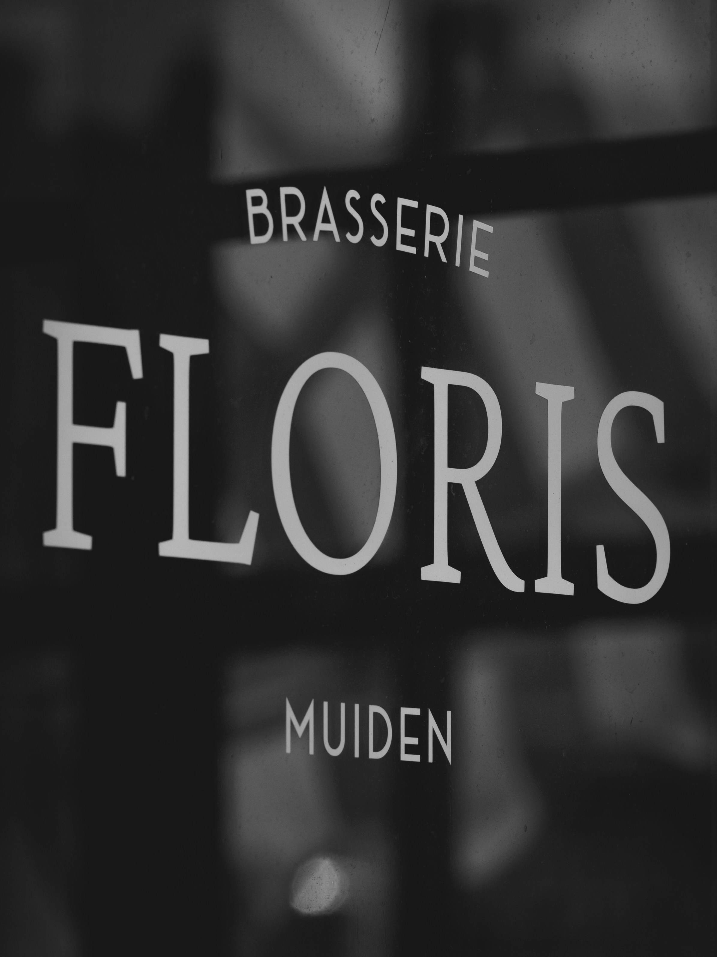 Glass-and-Glass Sign: Floris Brasserie in Focus