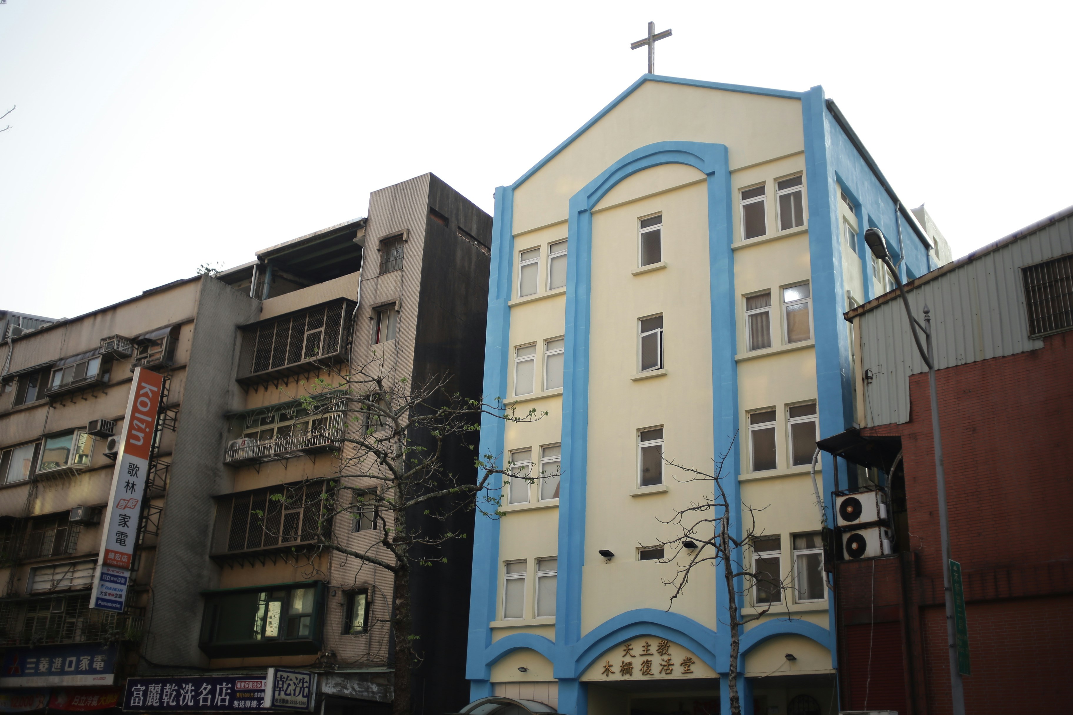 Blue-arched Building on a Busy Street