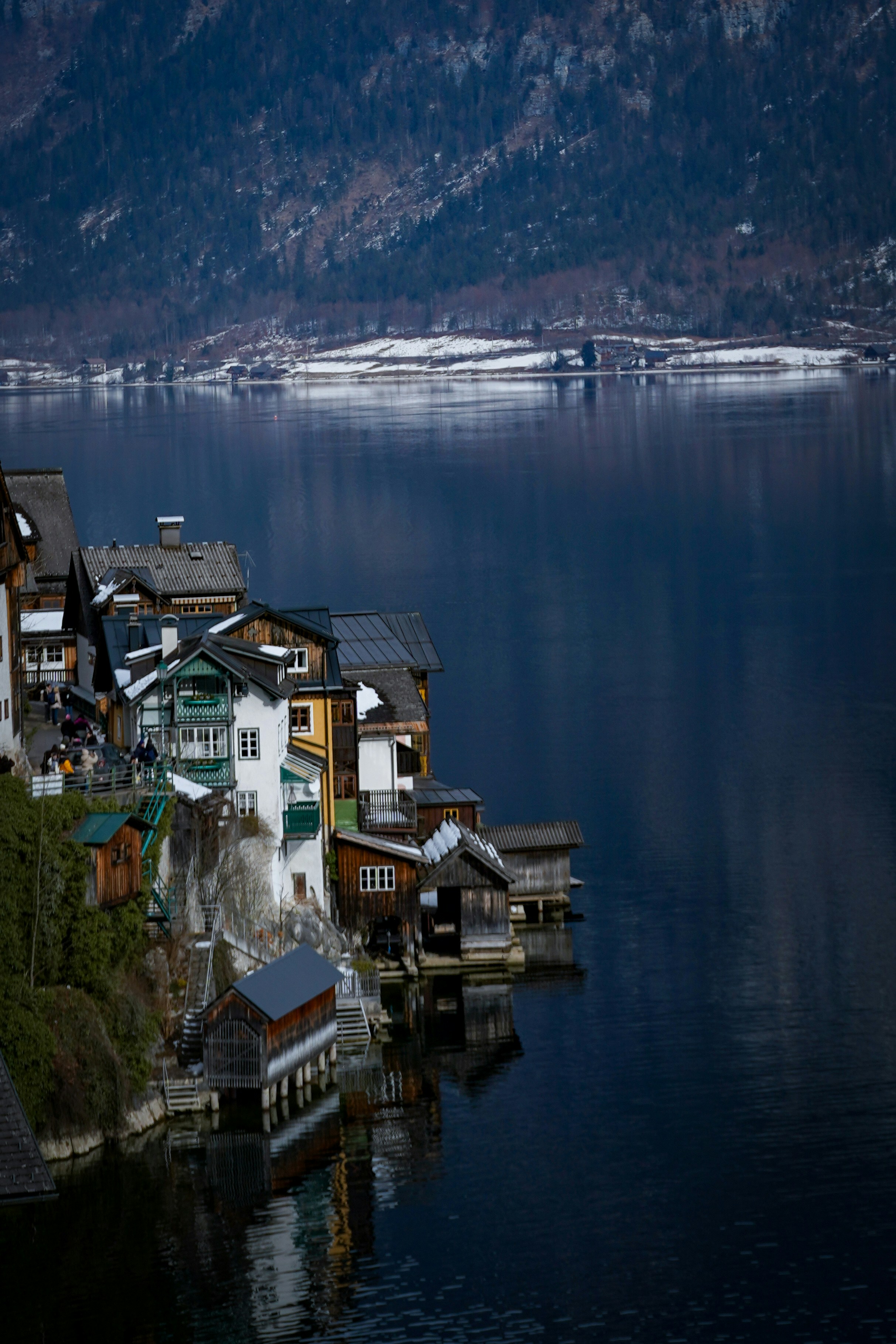 Colorful hillside houses cling to a fjord’s edge