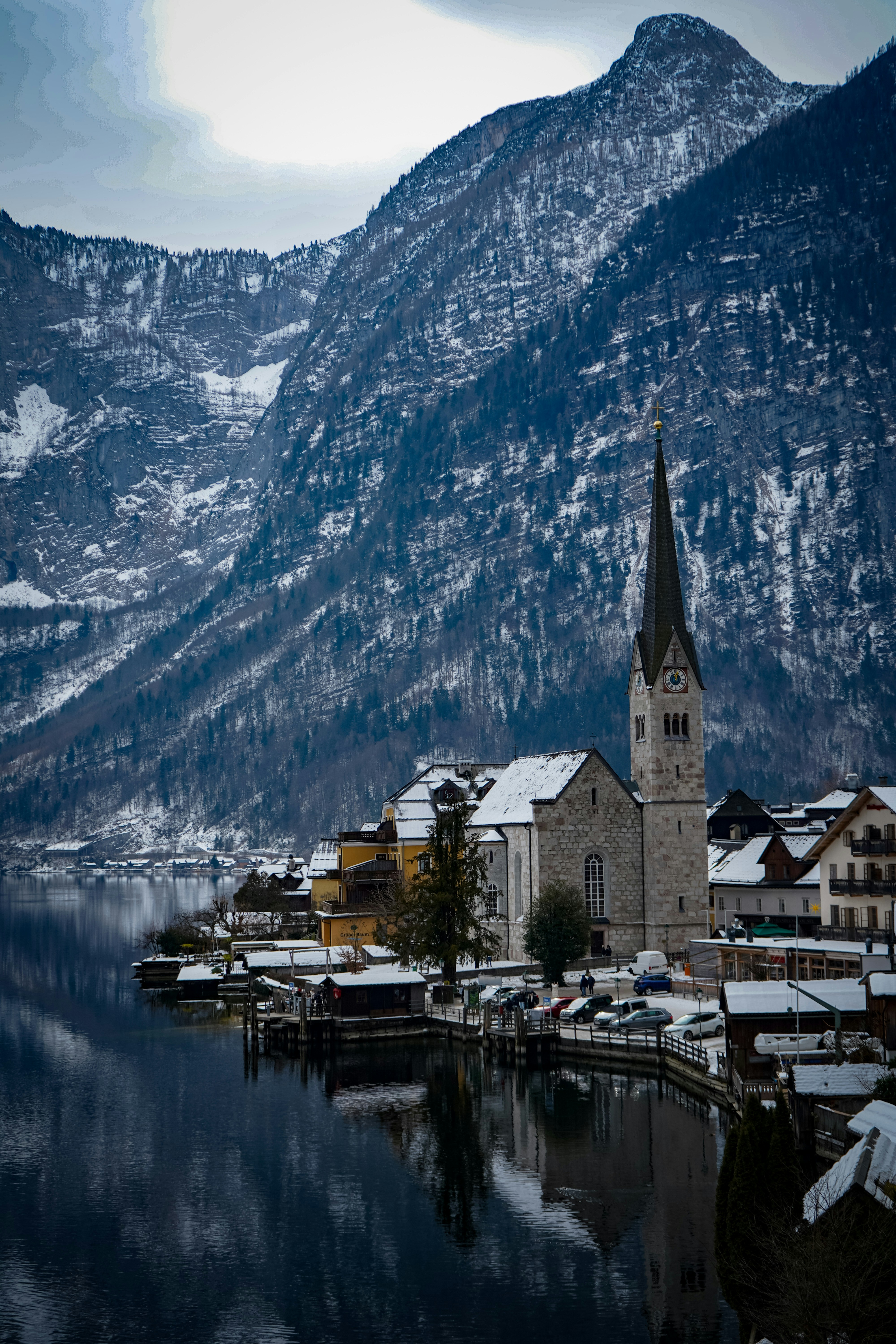 Snowbound St. Nicholas Church Anchors a Alpine Village by the Still Lake